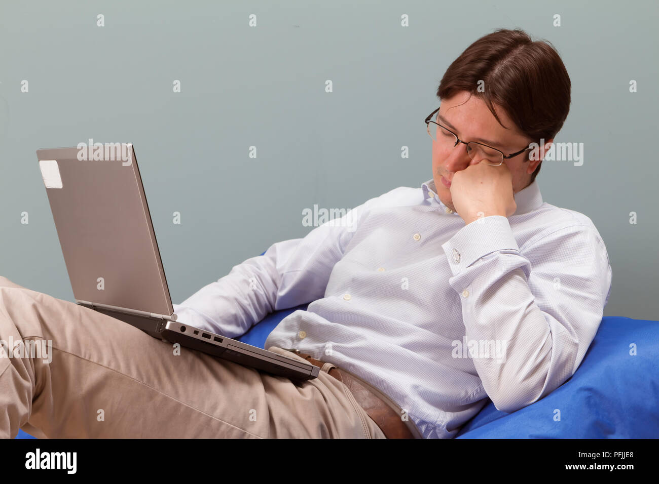 Sleepy man working on computer hi-res stock photography and images - Alamy
