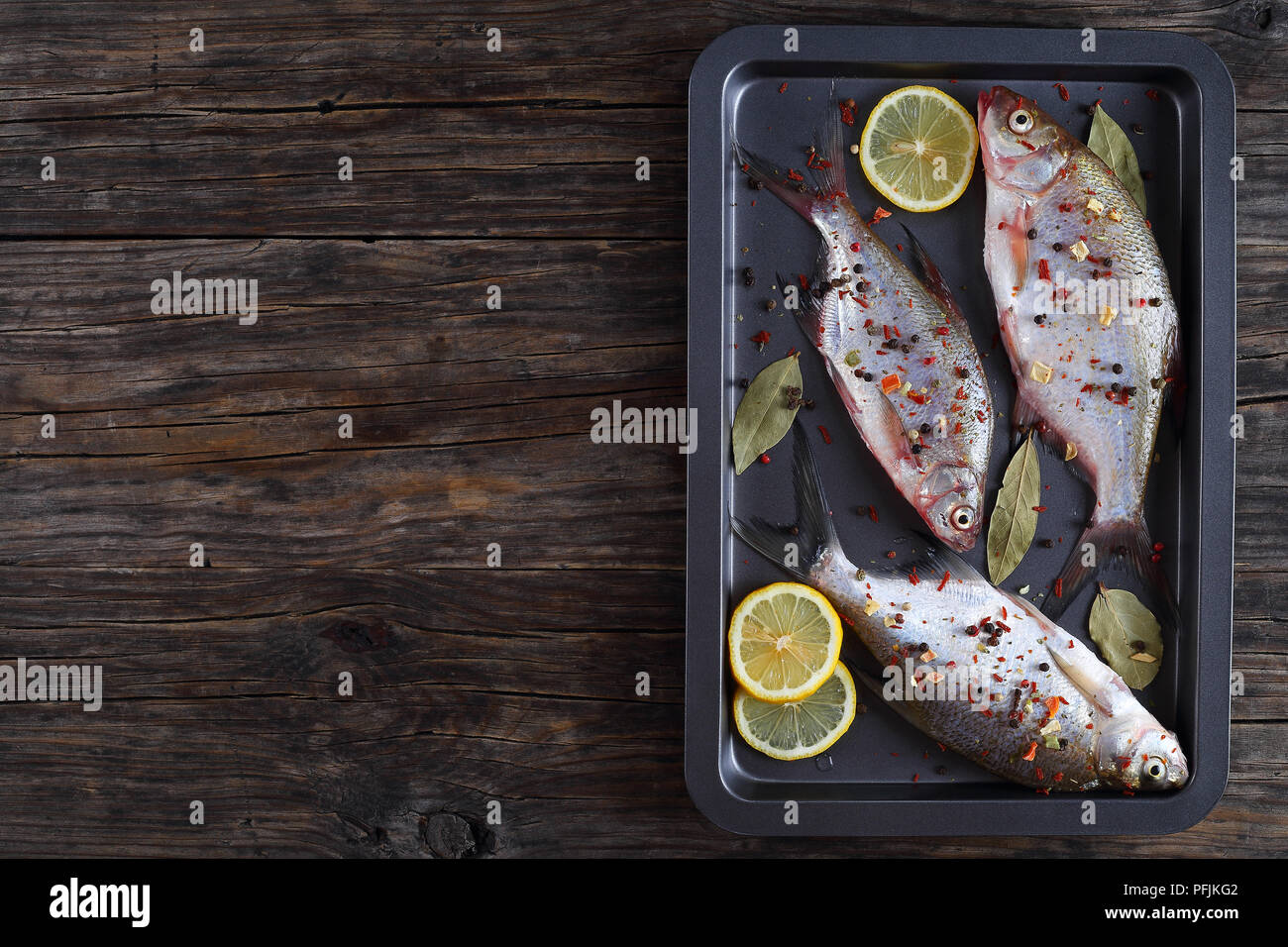raw fresh fish - river bream marinated with lemon slices, bay leaf ...