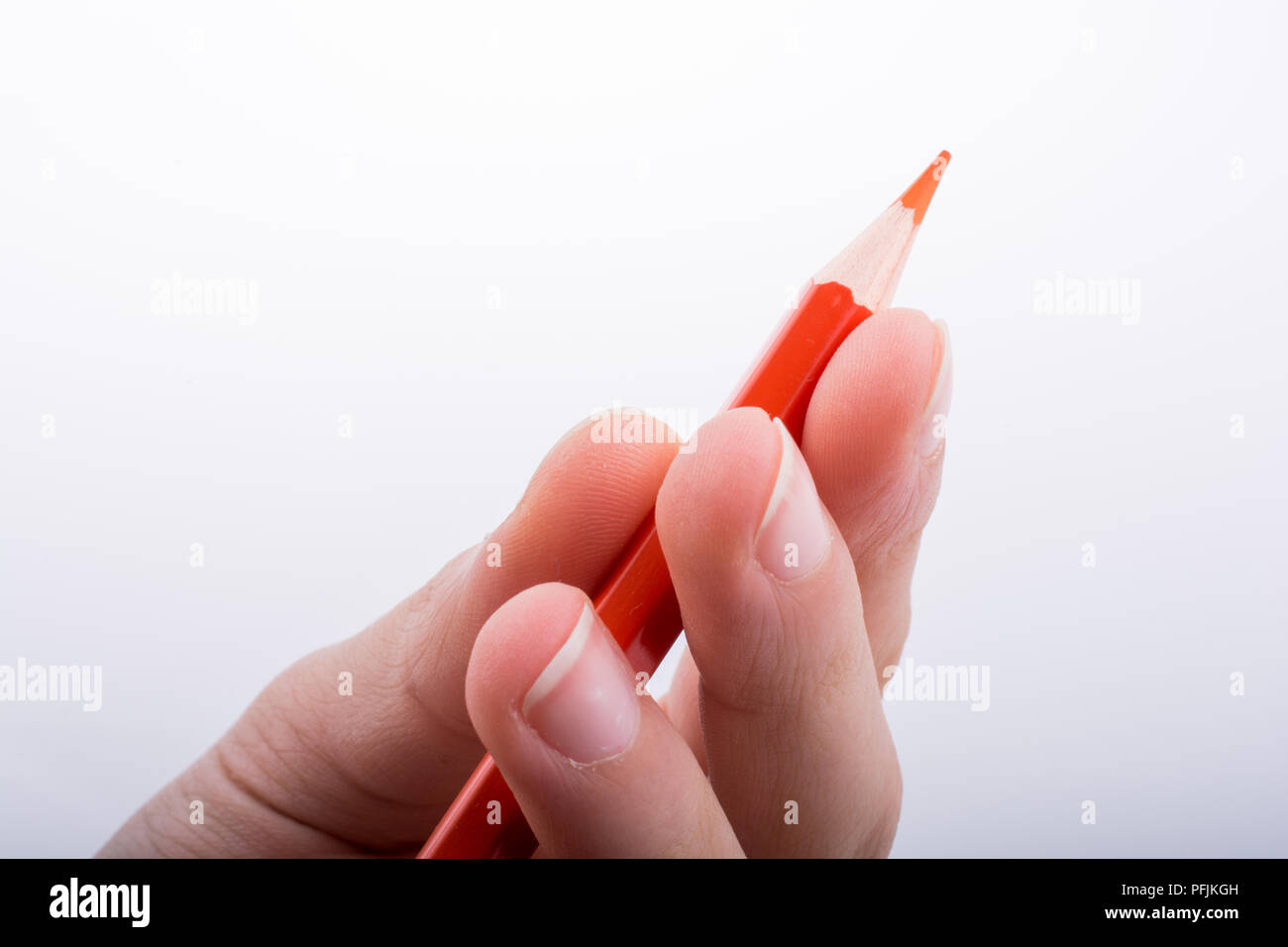 Hand holding color pencil on a white background Stock Photo - Alamy