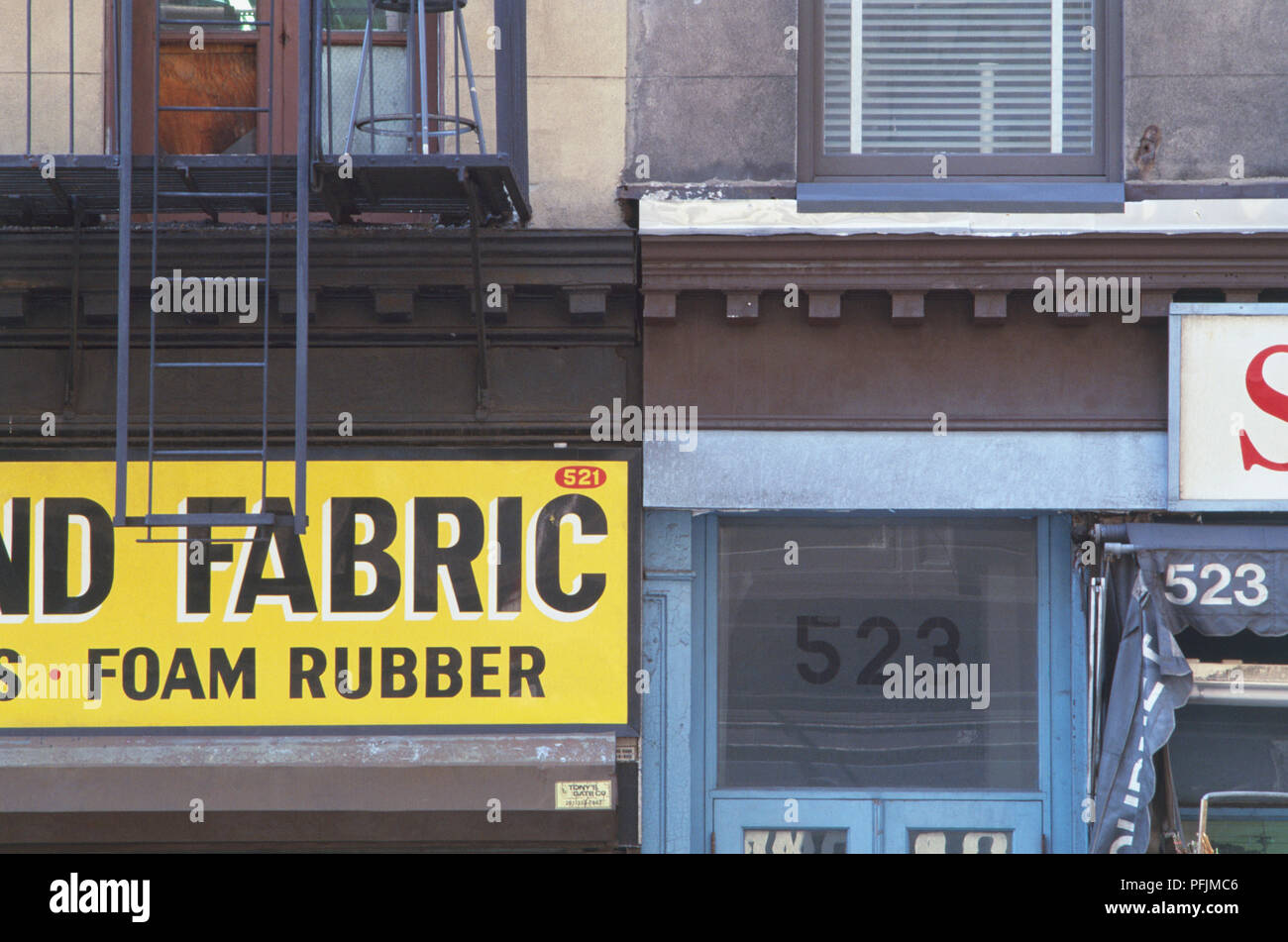 USA, New York, facade detail, street number '523' and sign above shop ...