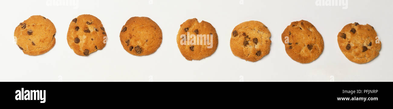 Seven chocolate chip cookies in a row Stock Photo - Alamy