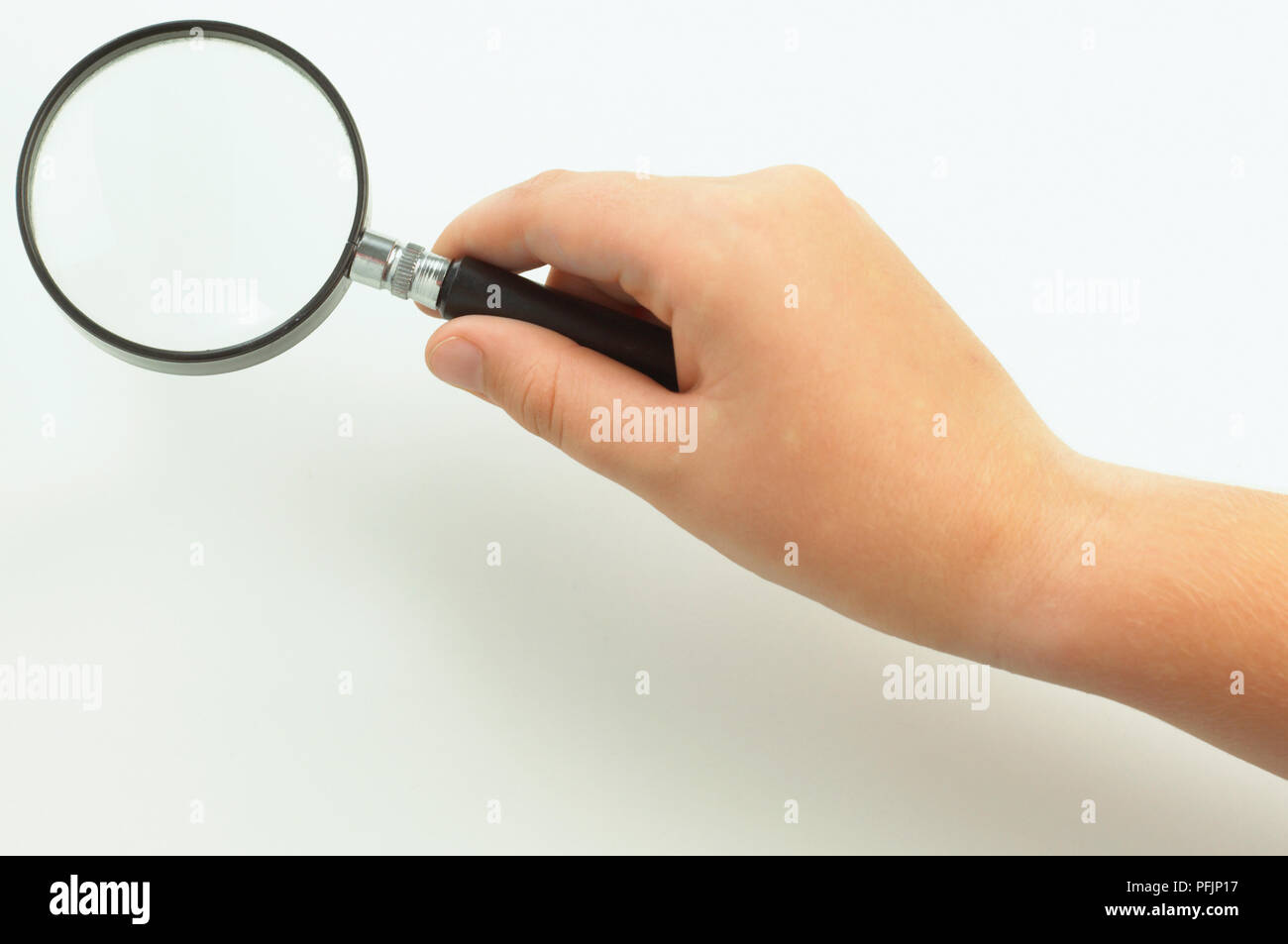 Hand holding magnifying glass Stock Photo - Alamy