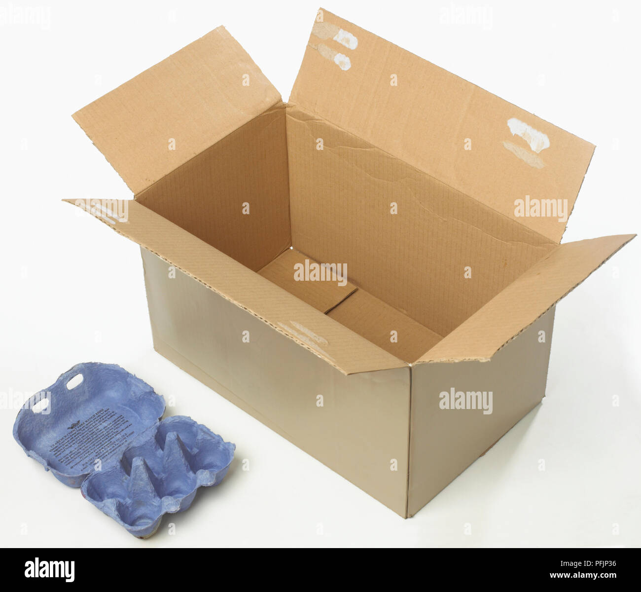 Blue open egg box next to open cardboard box Stock Photo - Alamy