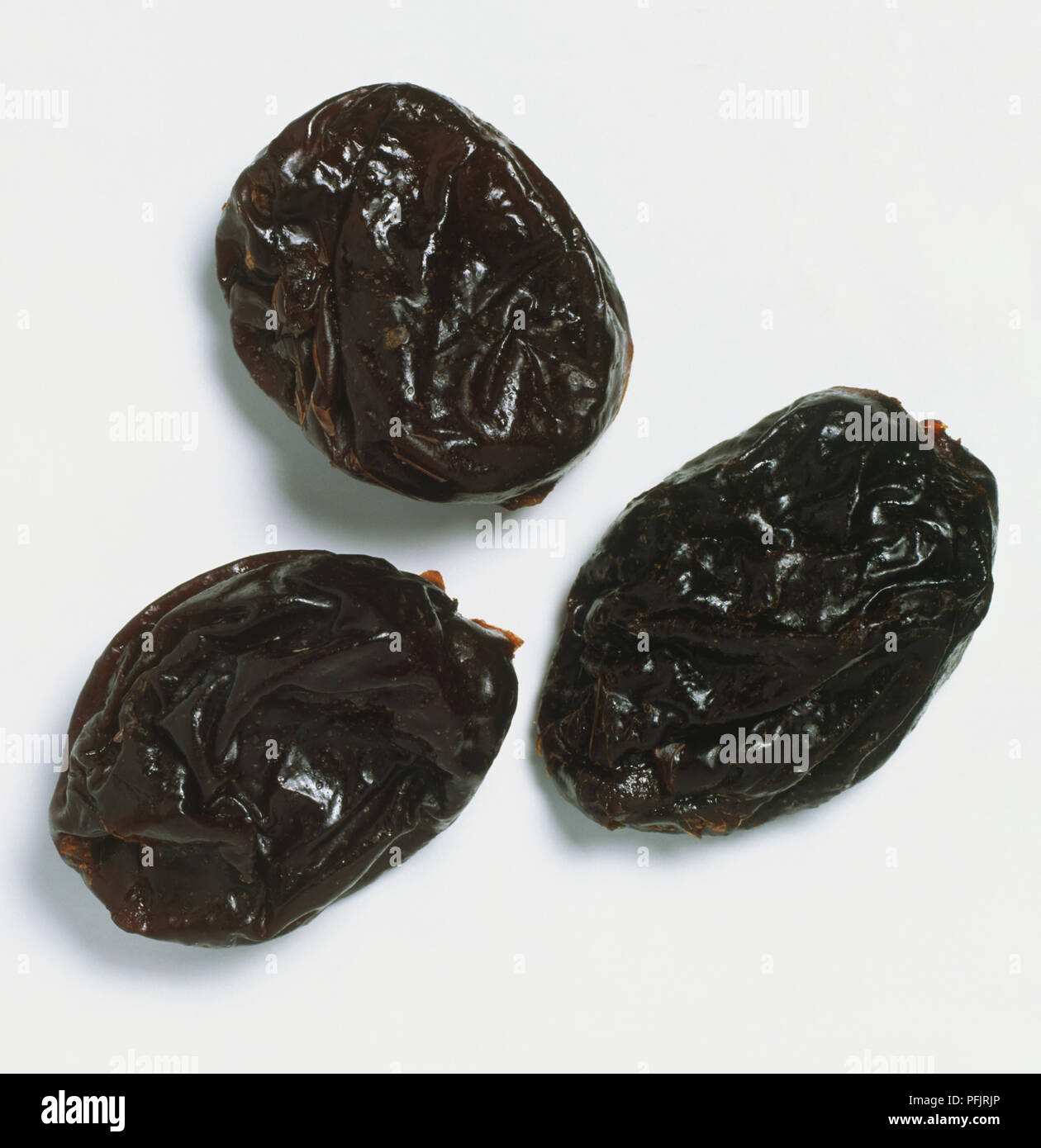 Three prunes, close up Stock Photo - Alamy