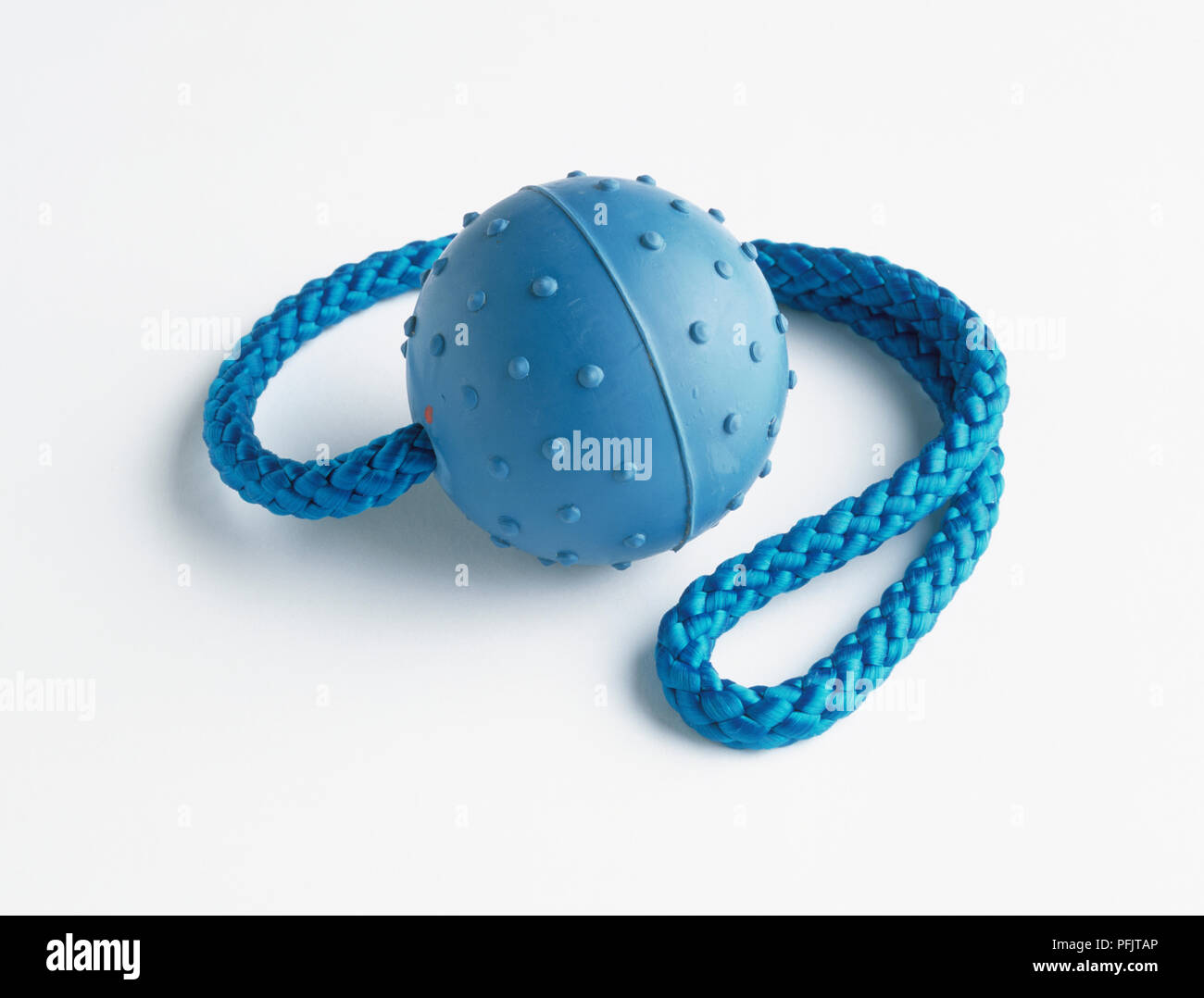 Blue plastic ball with bumpy surface and blue string attached on top ...