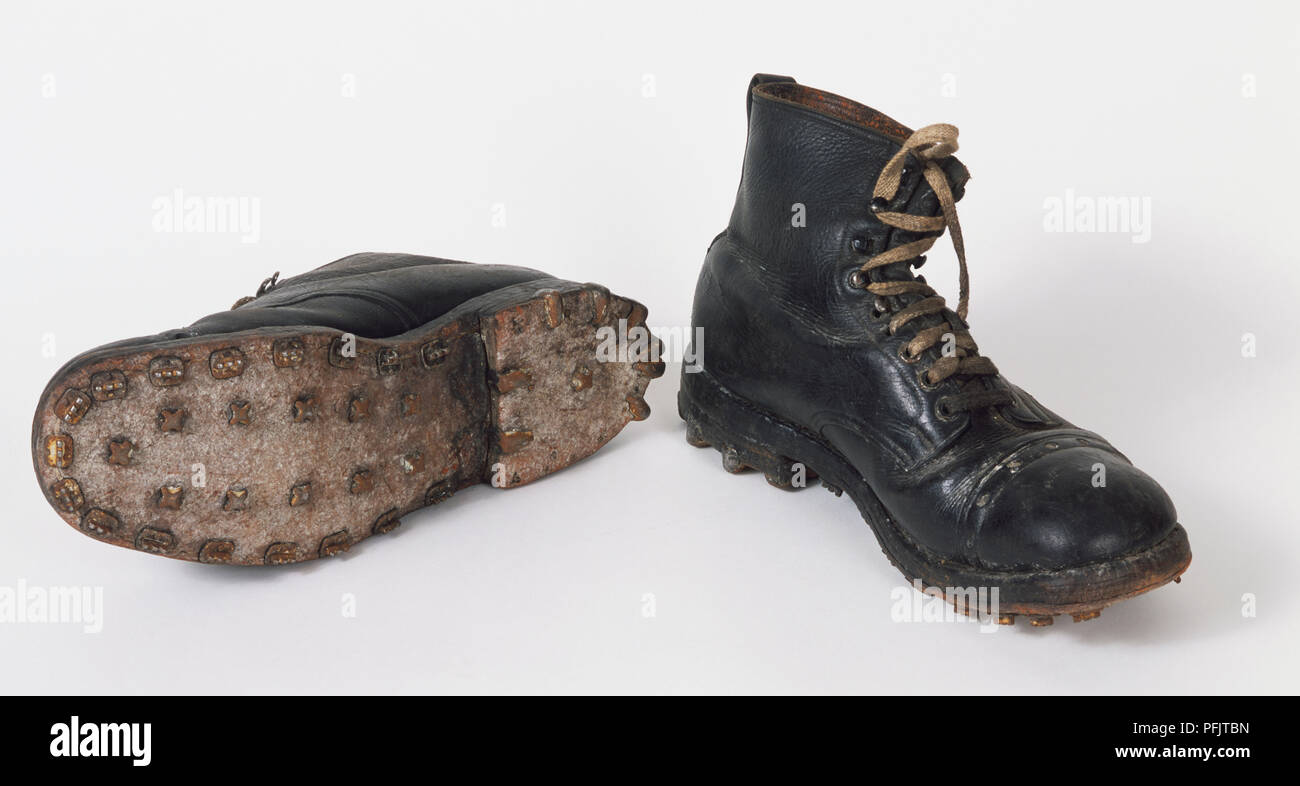 Pair of boots, one tipped over Stock Photo - Alamy