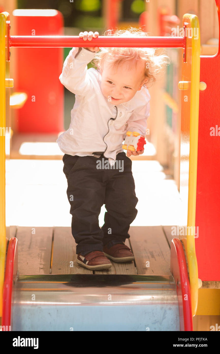 Happy kids playing on slide hi-res stock photography and images - Alamy