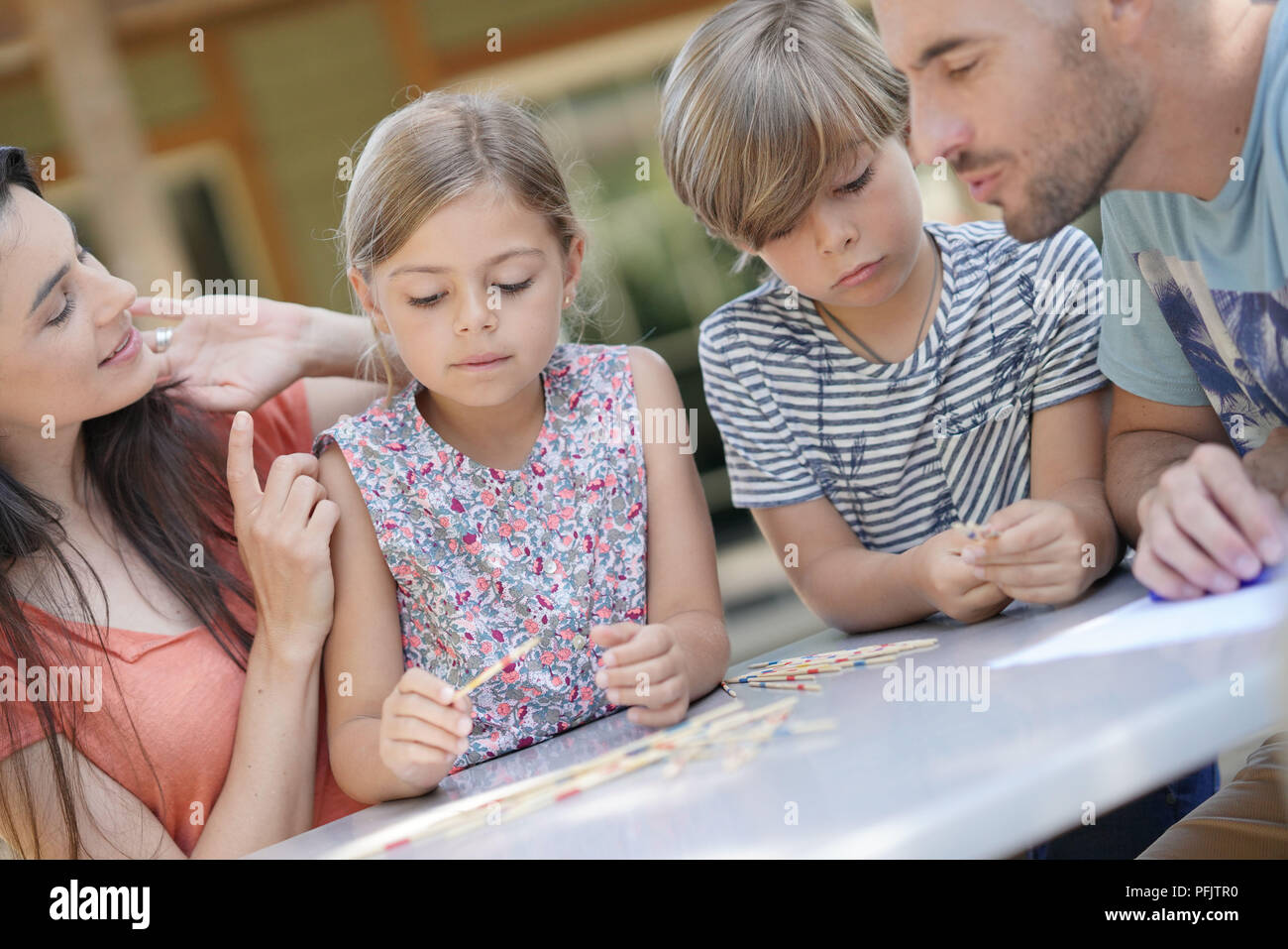 Happy family enjoying playing game together Stock Photo - Alamy