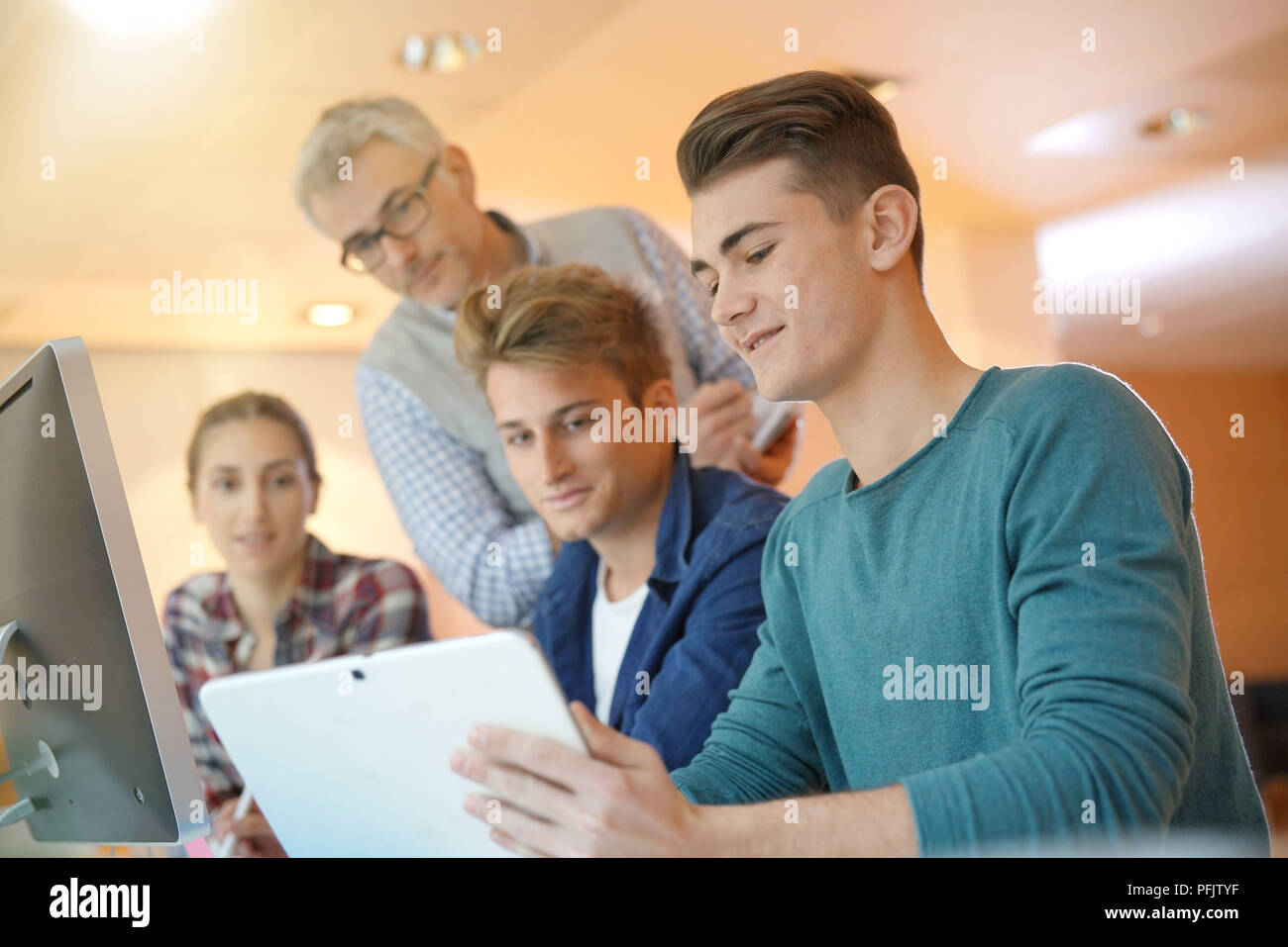 Students in class with teacher working on project Stock Photo - Alamy