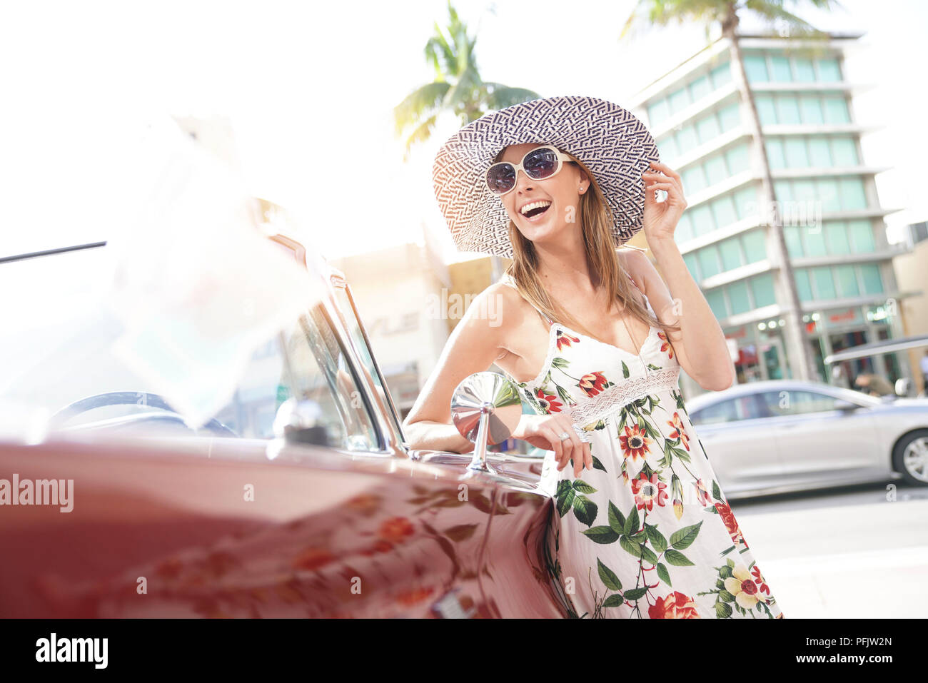 Model posing by old-fashioned car Stock Photo - Alamy