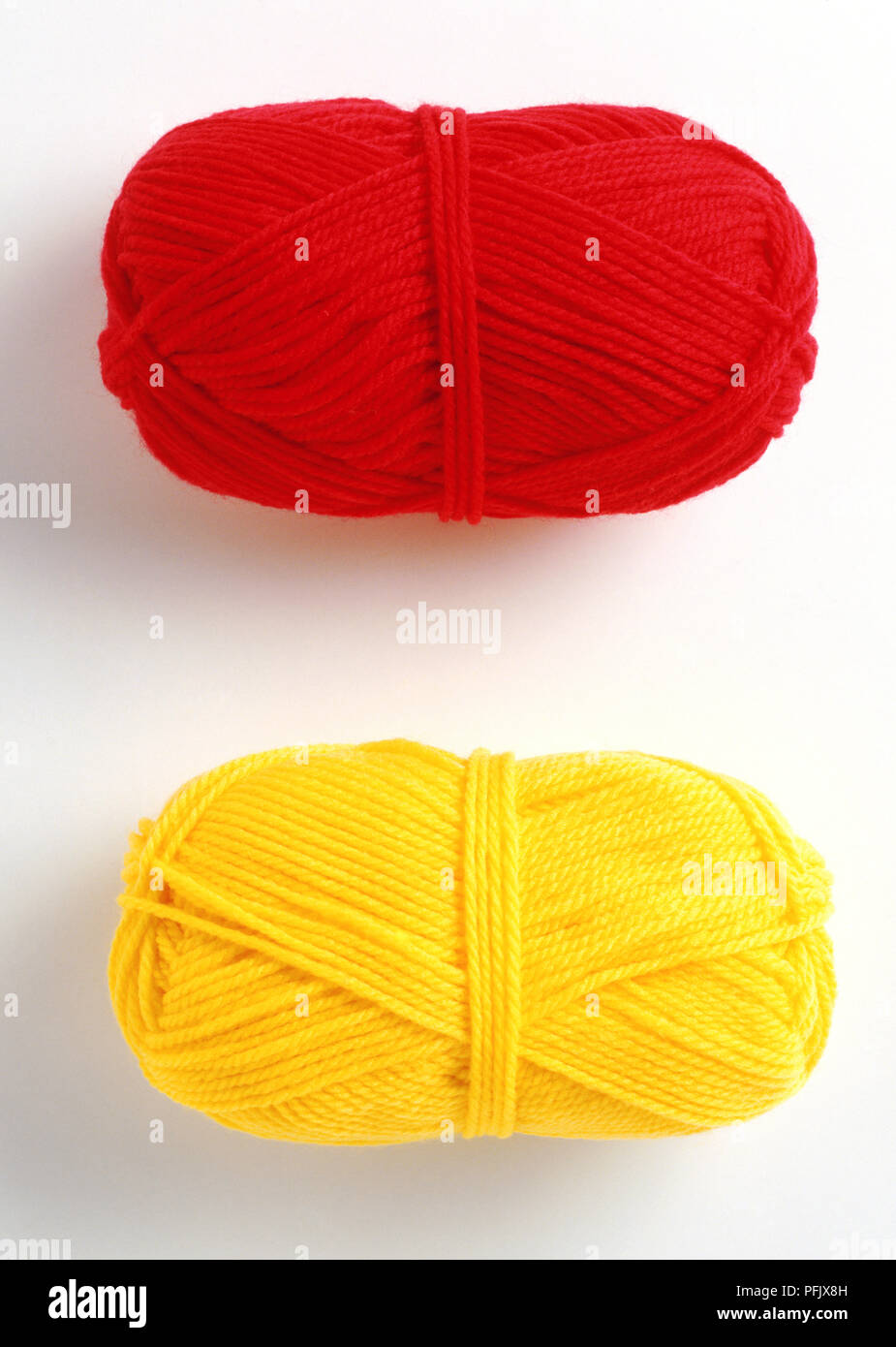 Spools of red and yellow yarn Stock Photo - Alamy