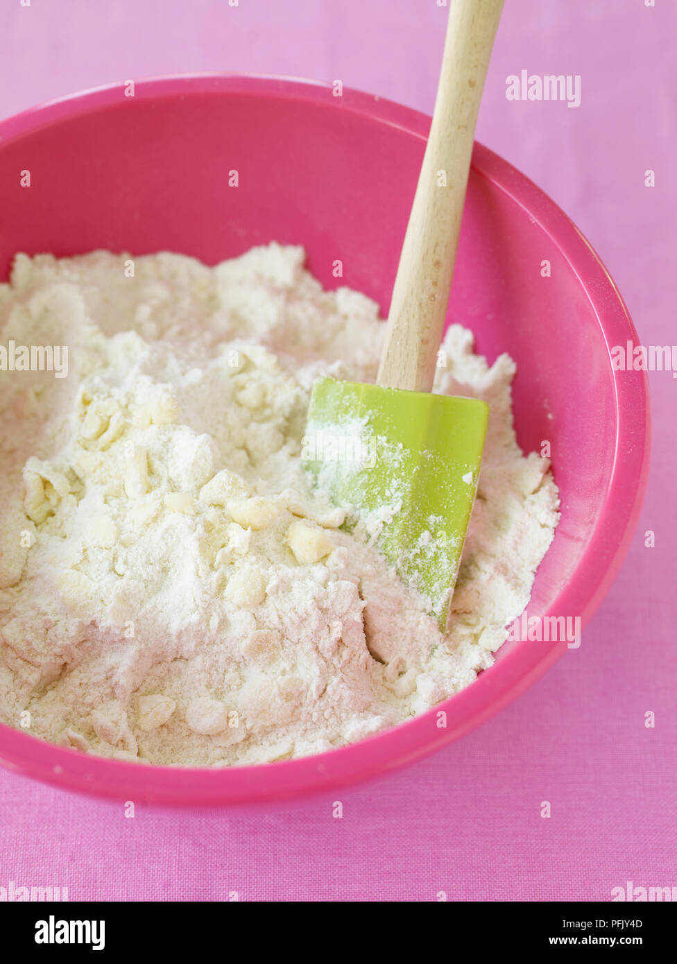 Flour, butter and rubber spatula in mixing bowl, close-up, view from ...
