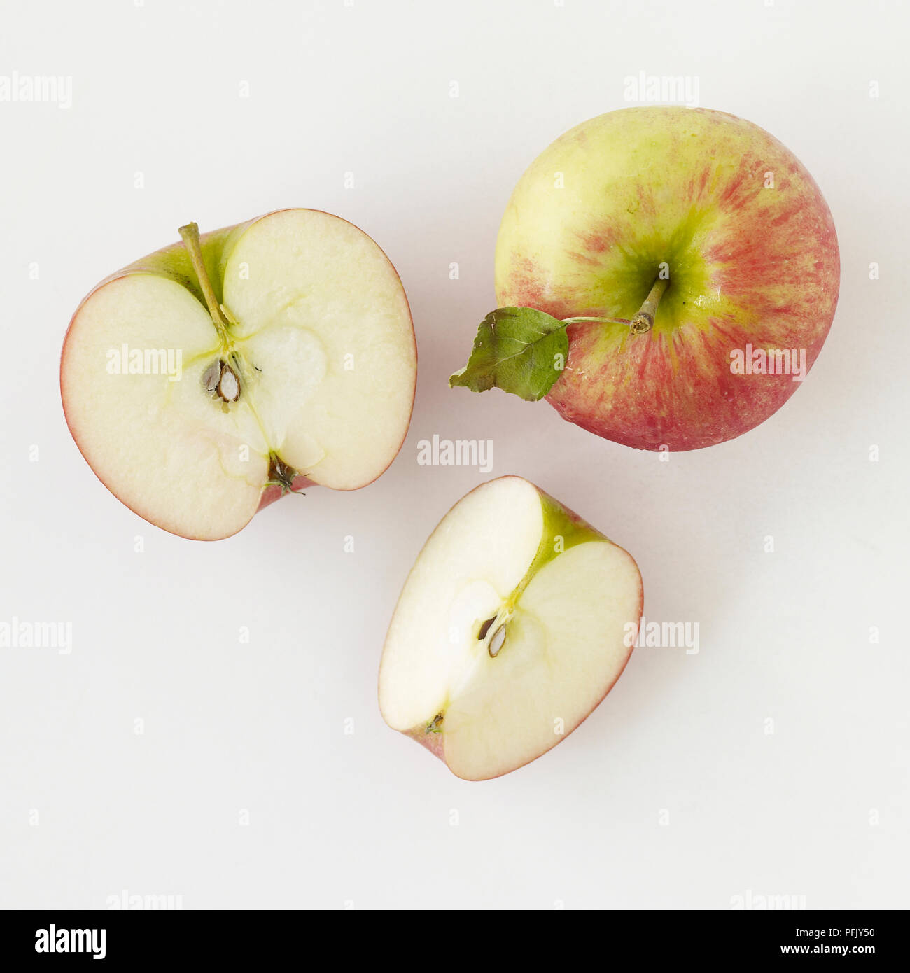 Whole apple, halved apple, and apple slice, close-up Stock Photo - Alamy