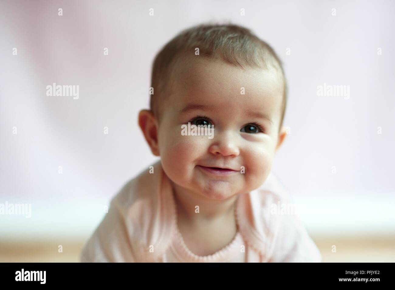 Portrait of baby girl, smiling, front view Stock Photo - Alamy