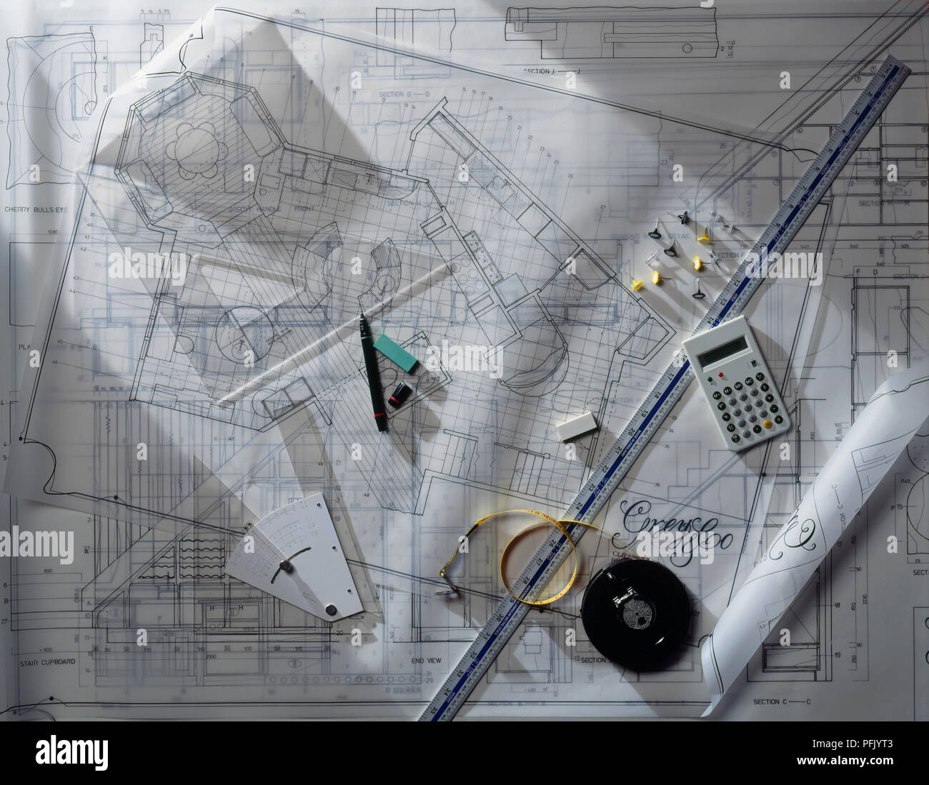 Architectural blueprints with rulers, calculator and measuring tape on ...