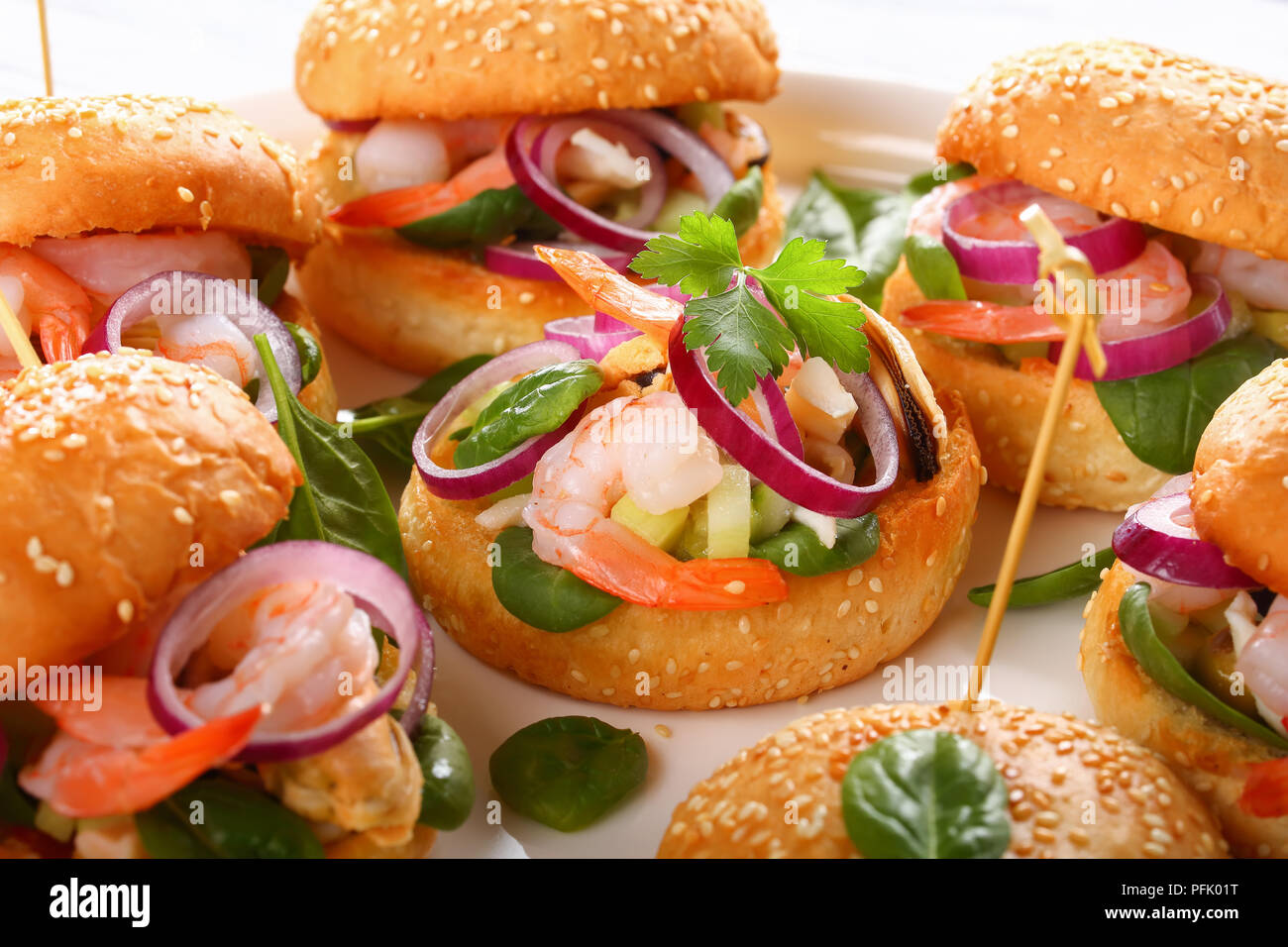 grilled juicy burgers pinned with bamboo skewers or pinchos with ...