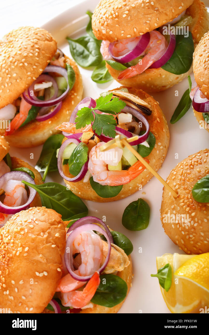 grilled juicy burgers pinned with bamboo skewers or pinchos with ...