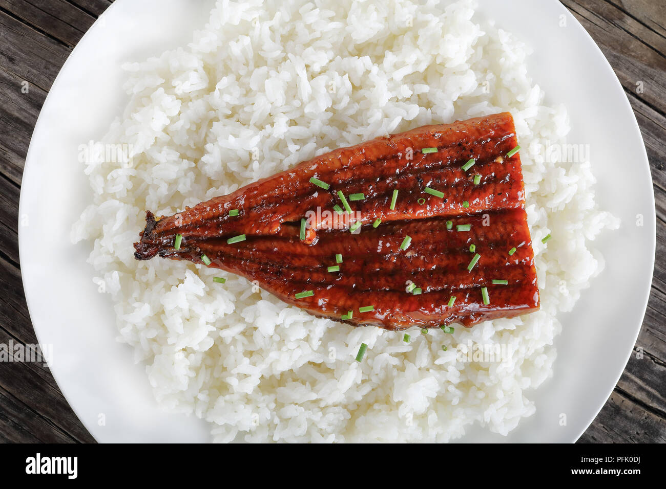 grilled unagi fillet or eel with tare sauce served with rice on white ...