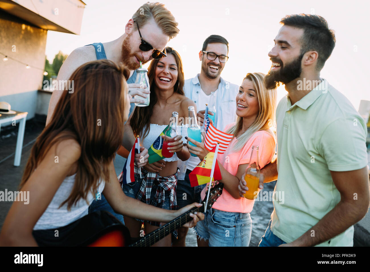 Group of happy friends having party on rooftop Stock Photo - Alamy