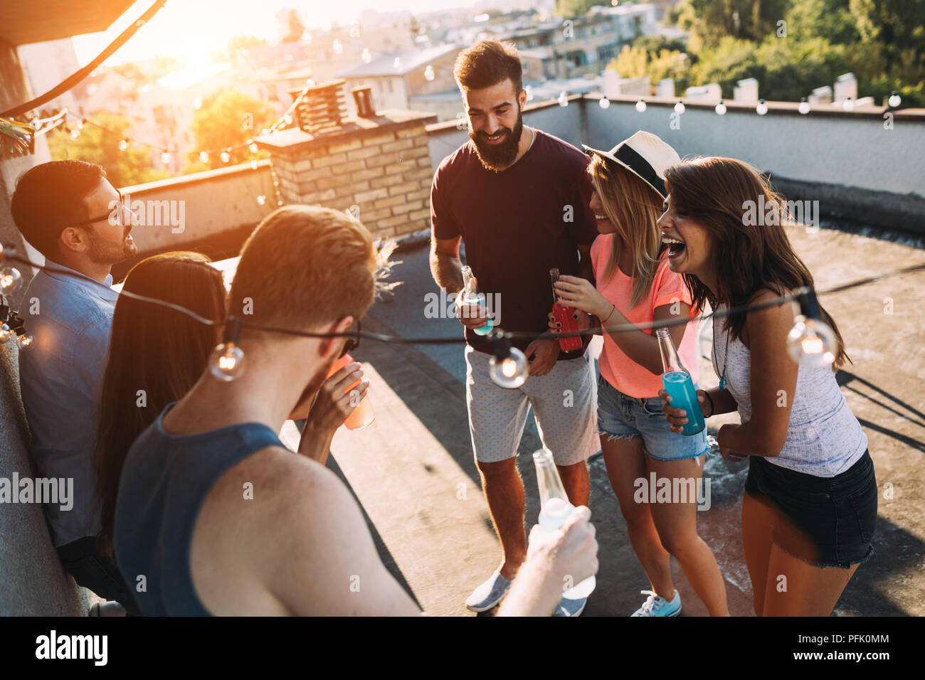 Group of happy friends having party on rooftop Stock Photo - Alamy
