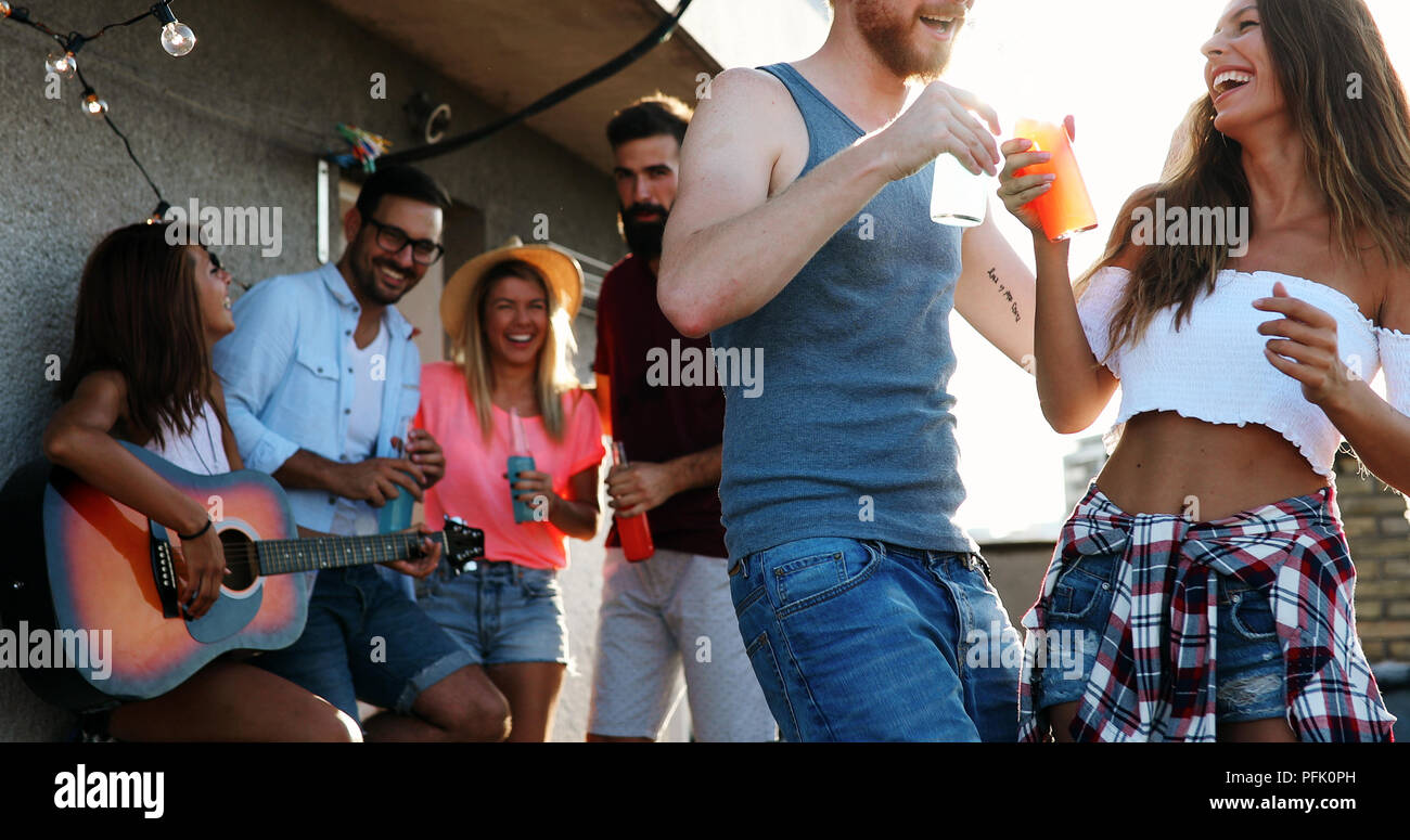 Friends having fun and drinking outdoor on a rooftop get together Stock ...