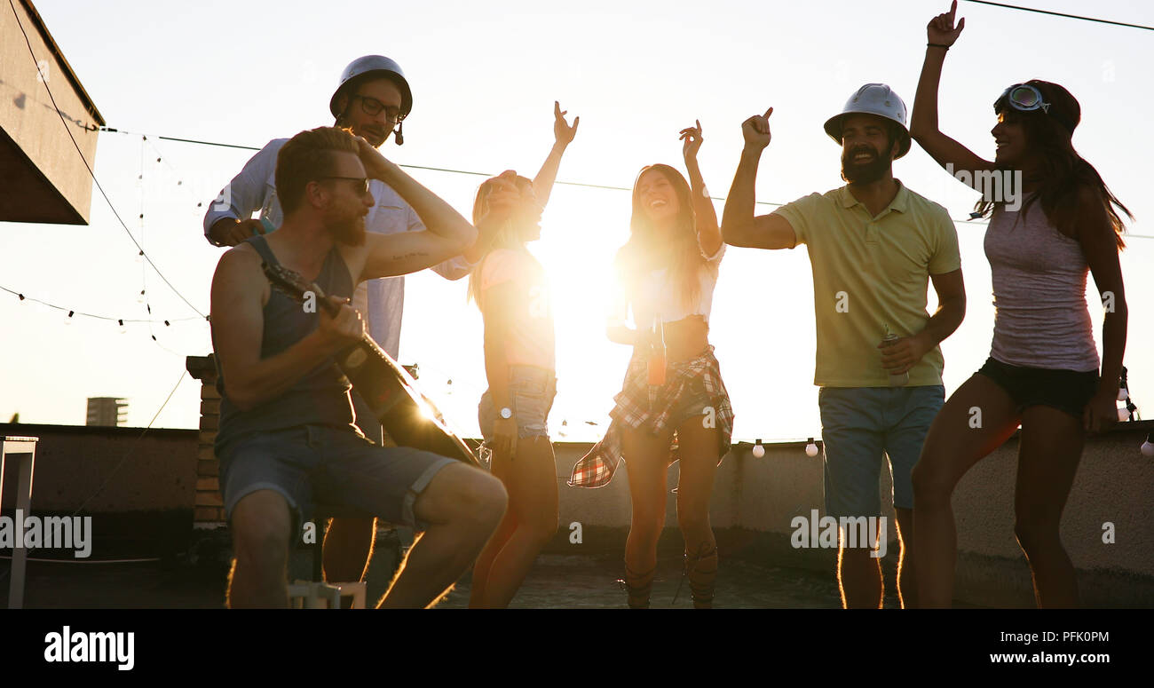 Friends having fun at rooftop party Stock Photo - Alamy
