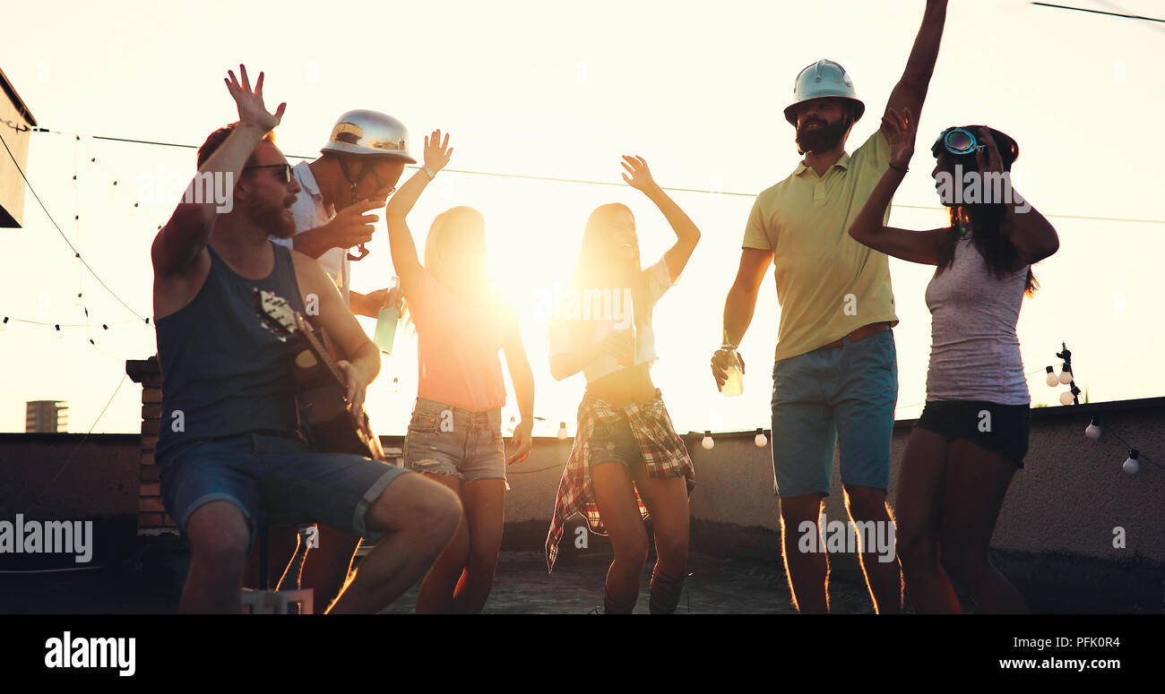 Friends having fun at rooftop party Stock Photo - Alamy