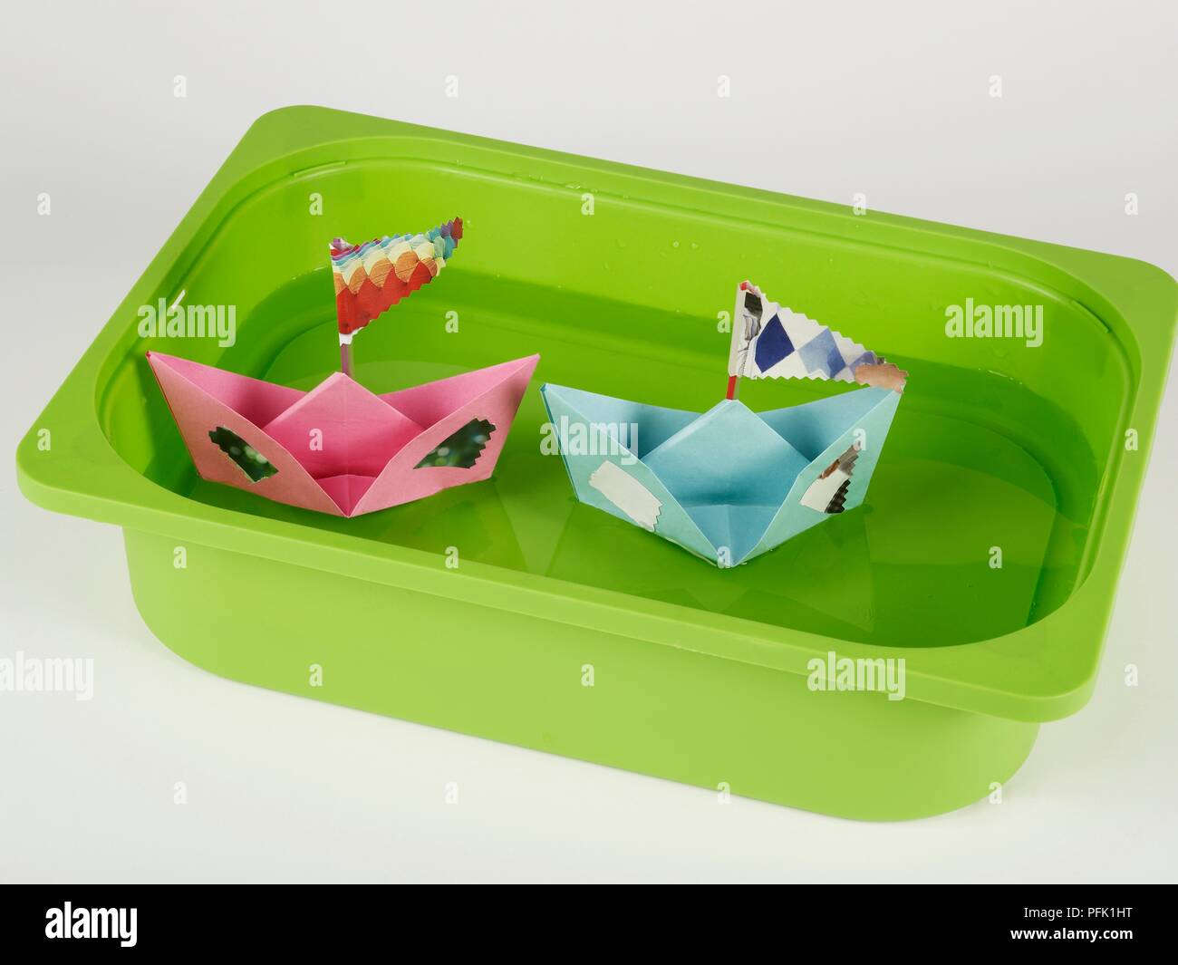 Paper boats in plastic tub, close-up Stock Photo - Alamy