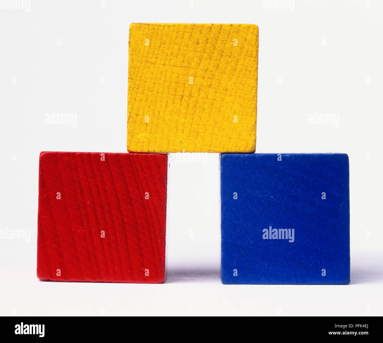 Three stacked cubes, red, blue and yellow Stock Photo - Alamy