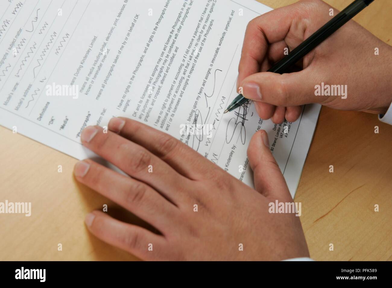 Man's hand signing a contract with a pen, close-up Stock Photo - Alamy