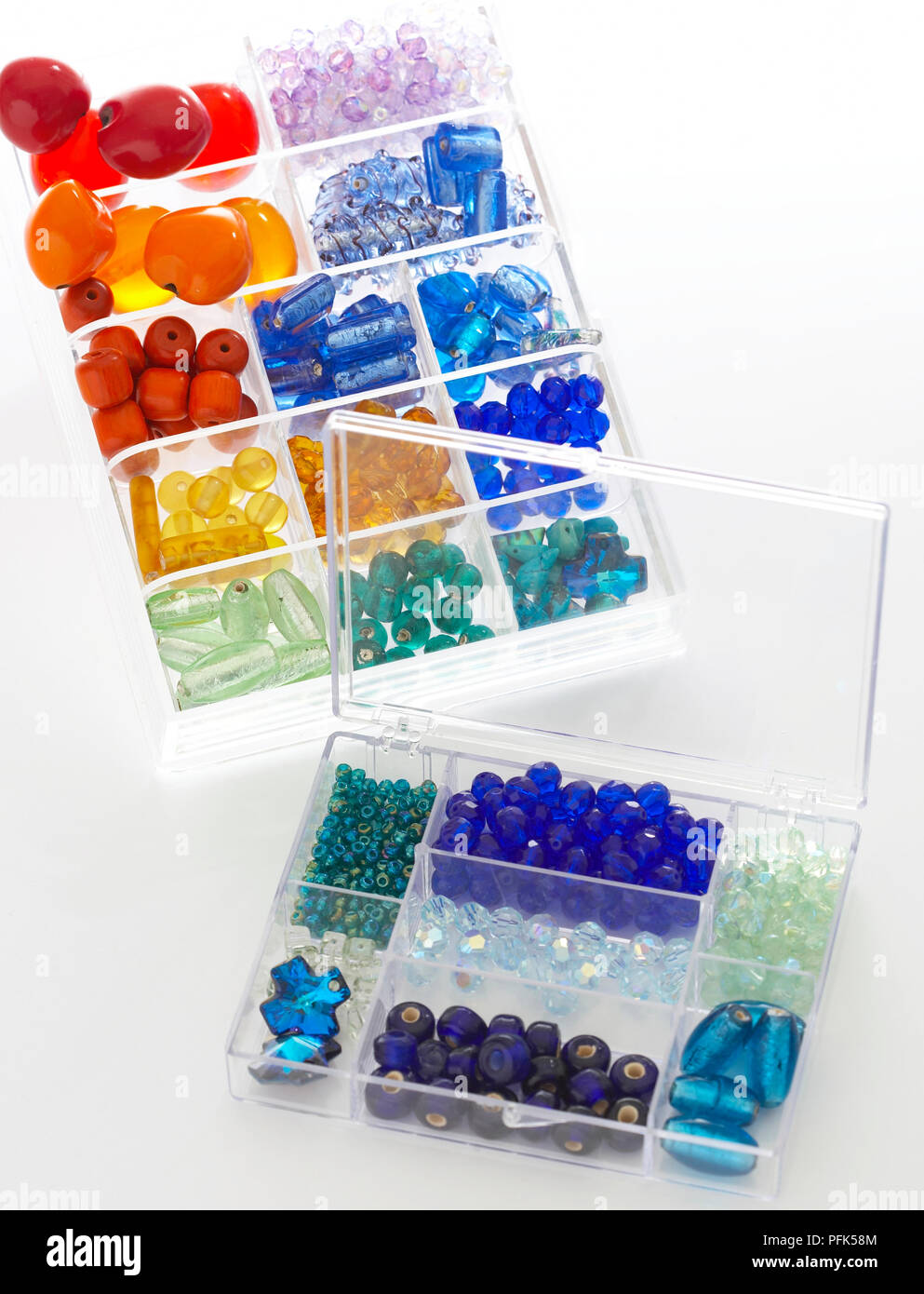 Two clear storage boxes containing assortment of differently shaped and ...