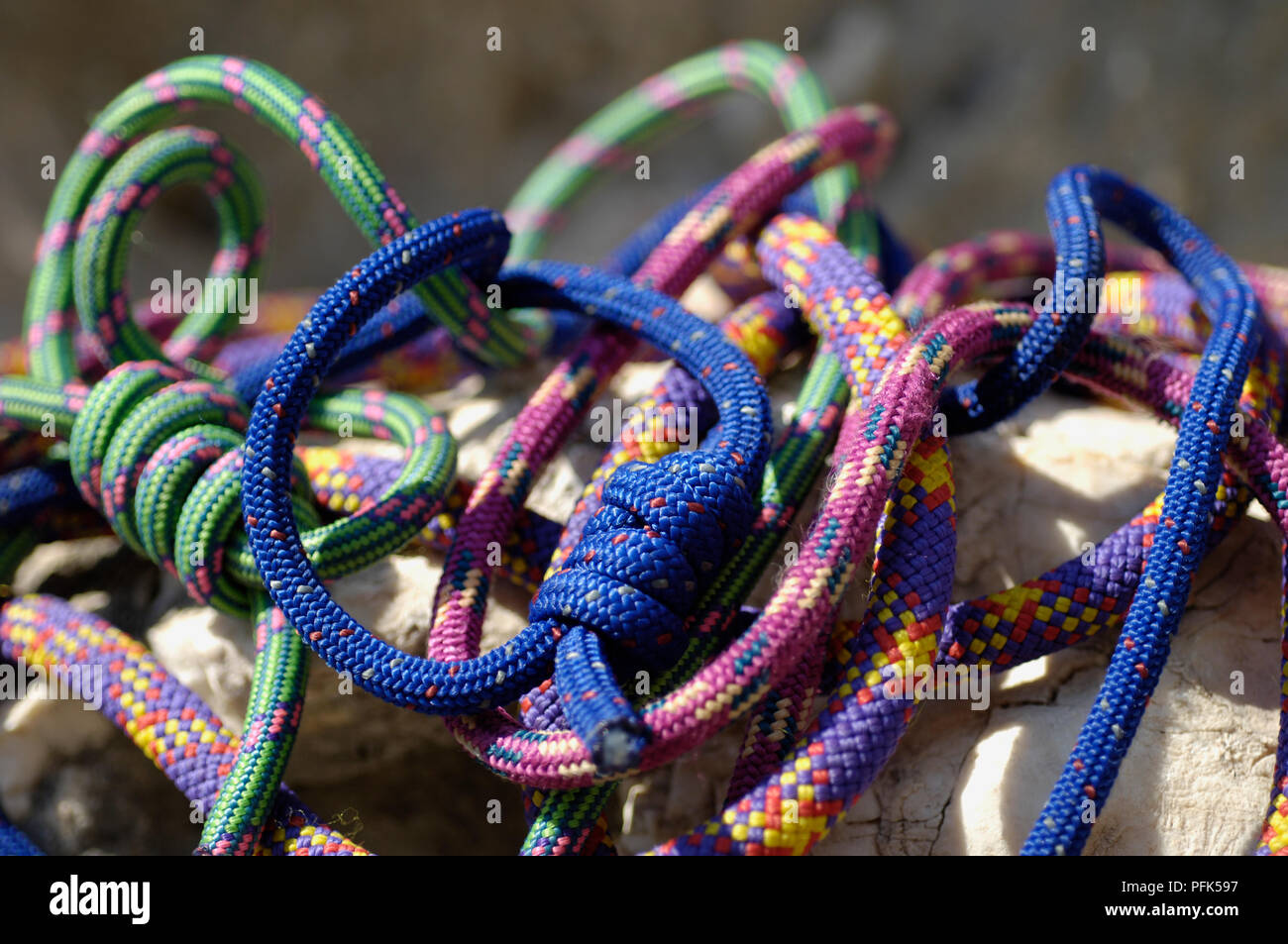 Tangle of multi-coloured climbing ropes on rock Stock Photo - Alamy