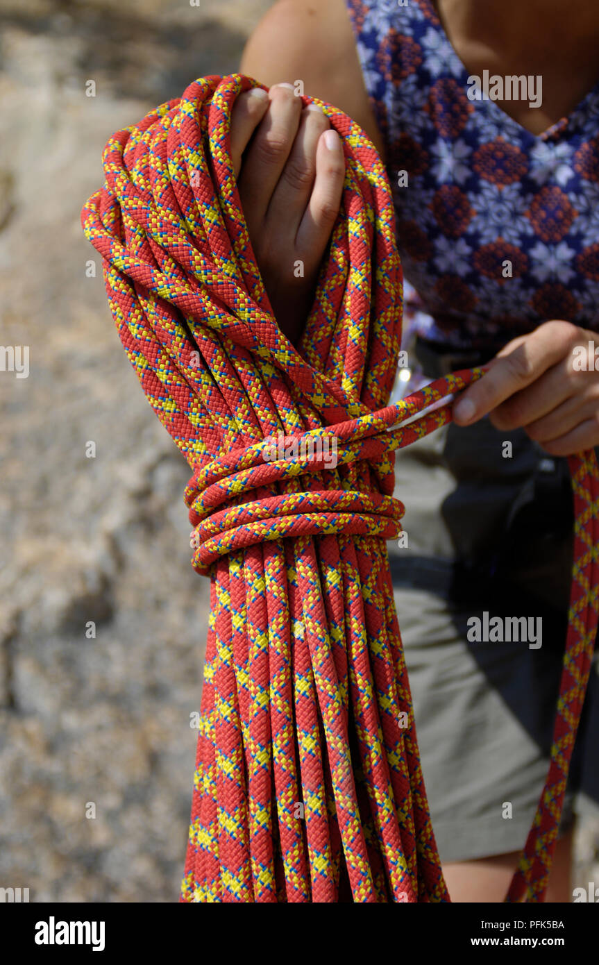 Wrapping end of rope around loops Stock Photo - Alamy