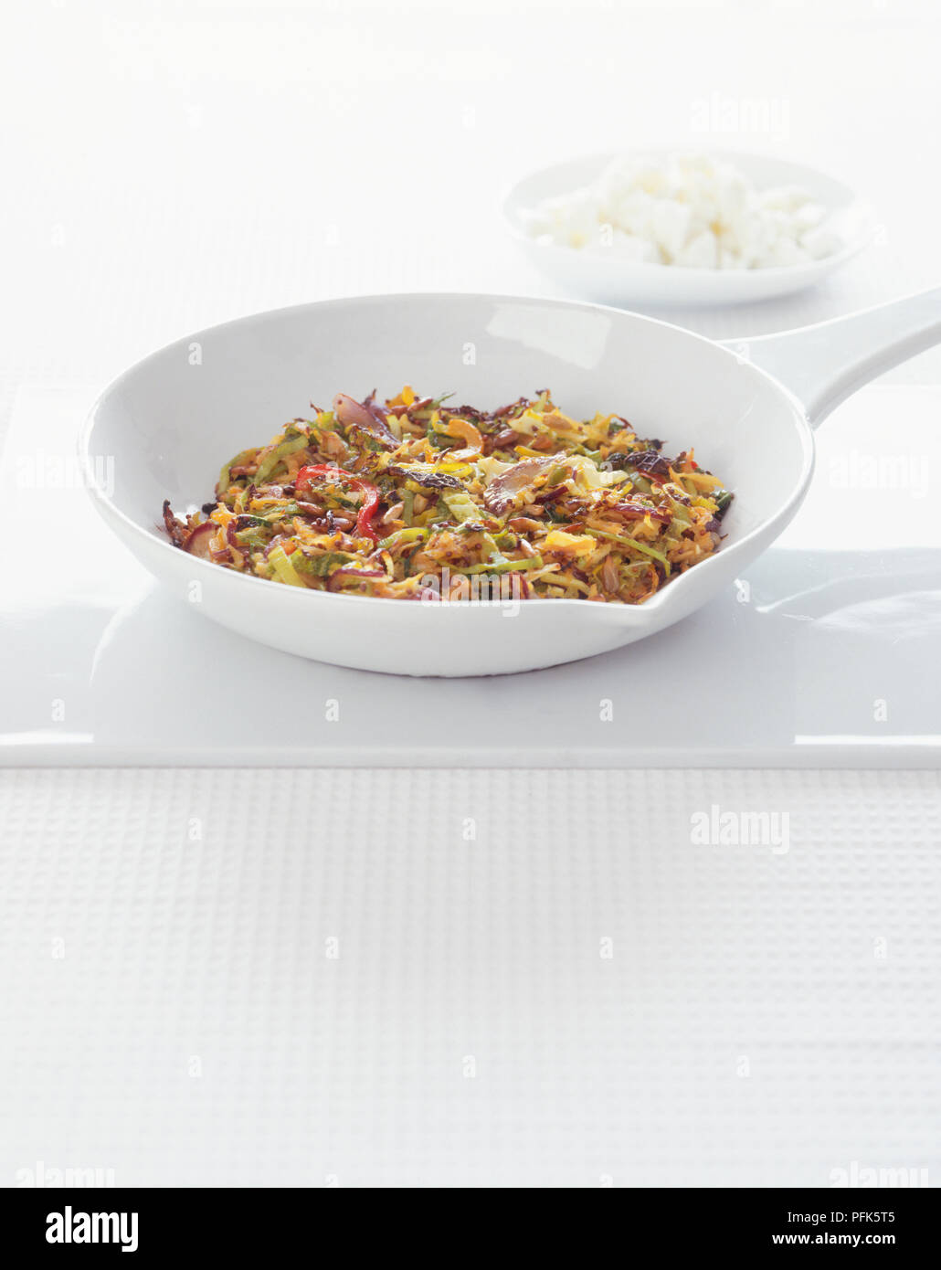 Mixed vegetable rosti in pan, and bowl of rice Stock Photo - Alamy