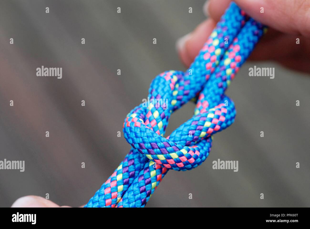 Hands tying reef knot, close-up Stock Photo - Alamy