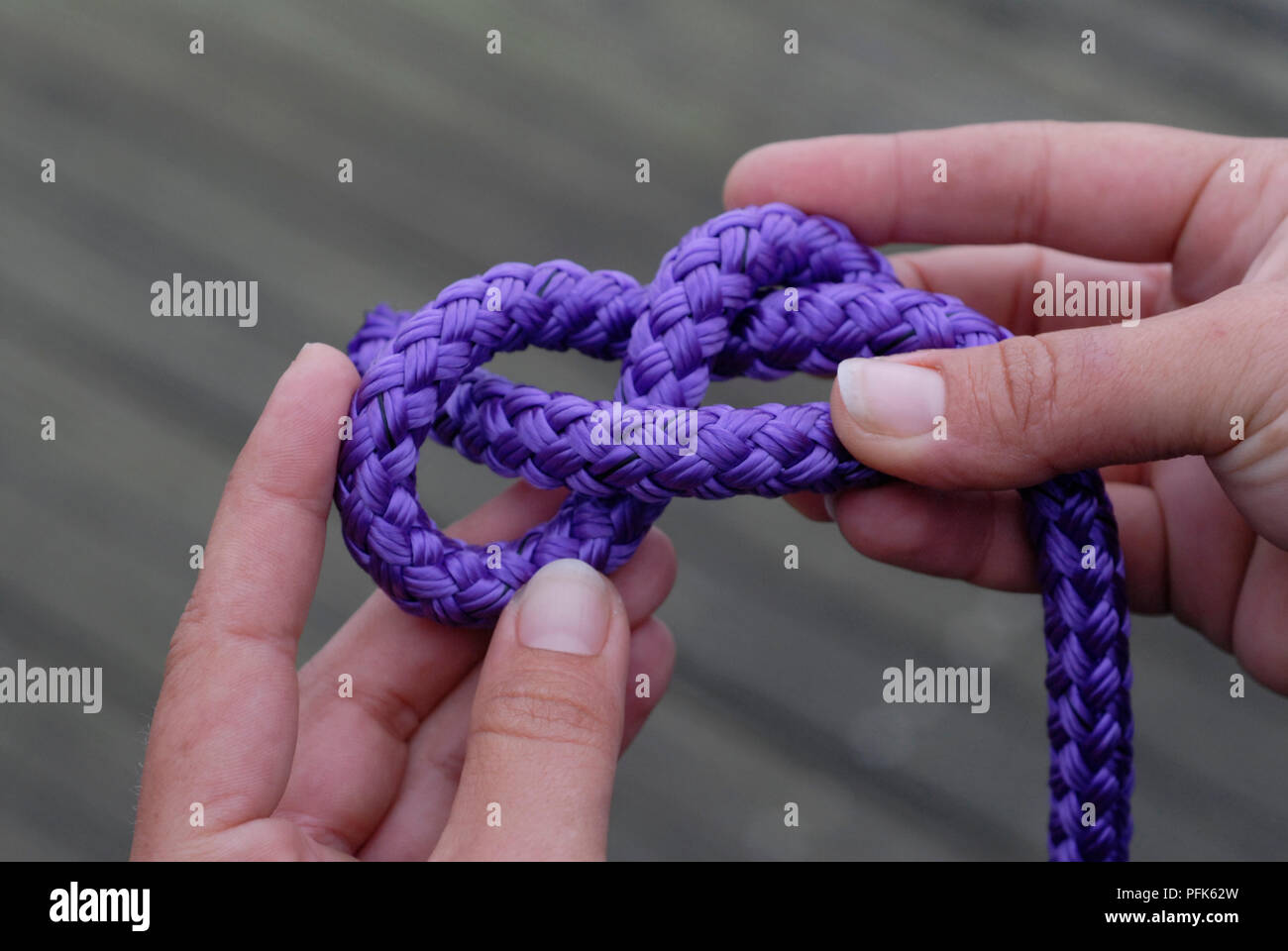 Hands tying knot, close up Stock Photo - Alamy