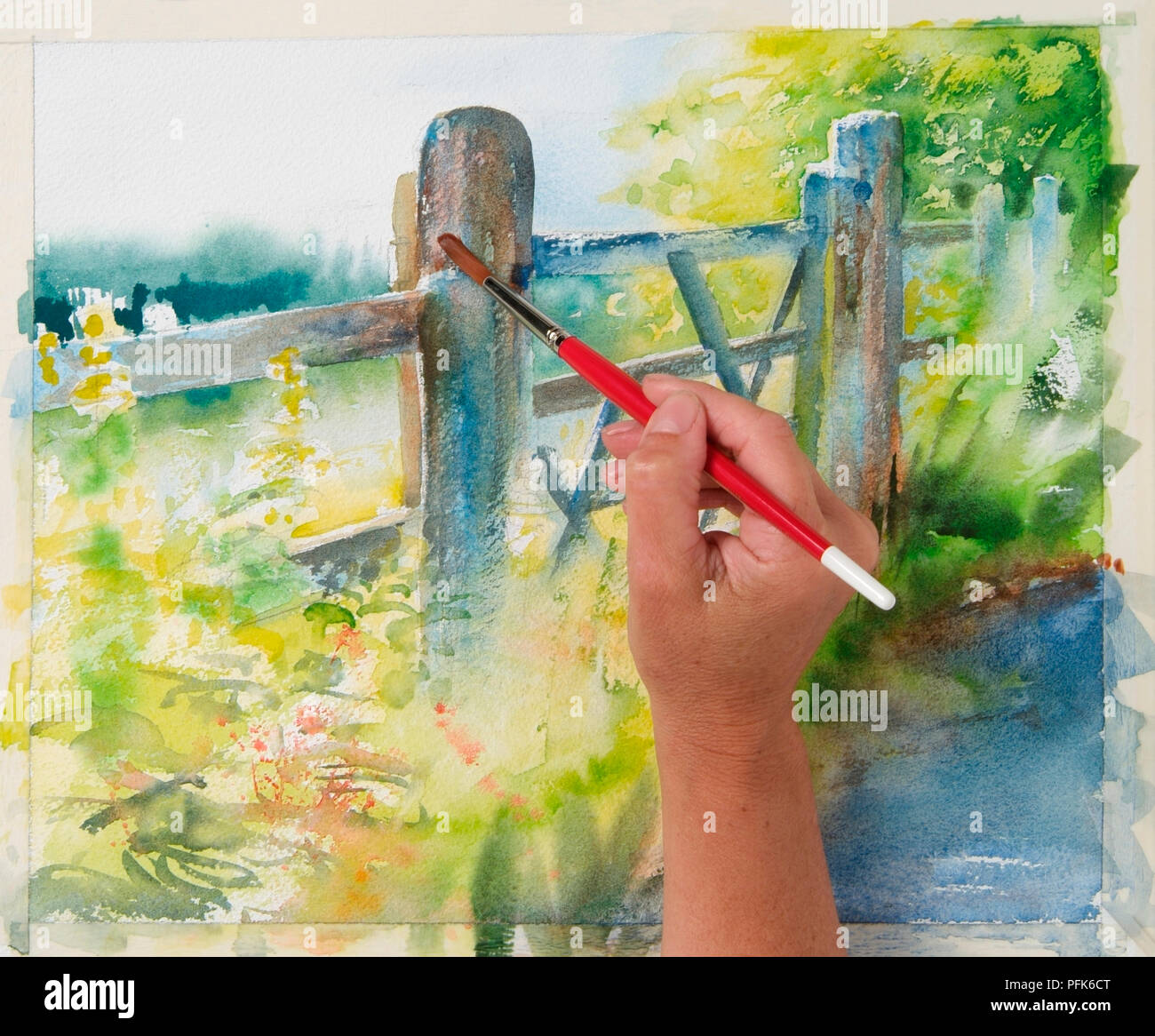 Hand painting gate in field with watercolour paint, close-up Stock ...