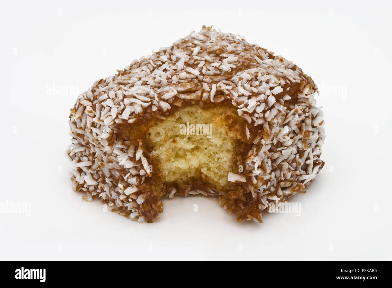Lamington sponge cake with a bite taken from it Stock Photo - Alamy