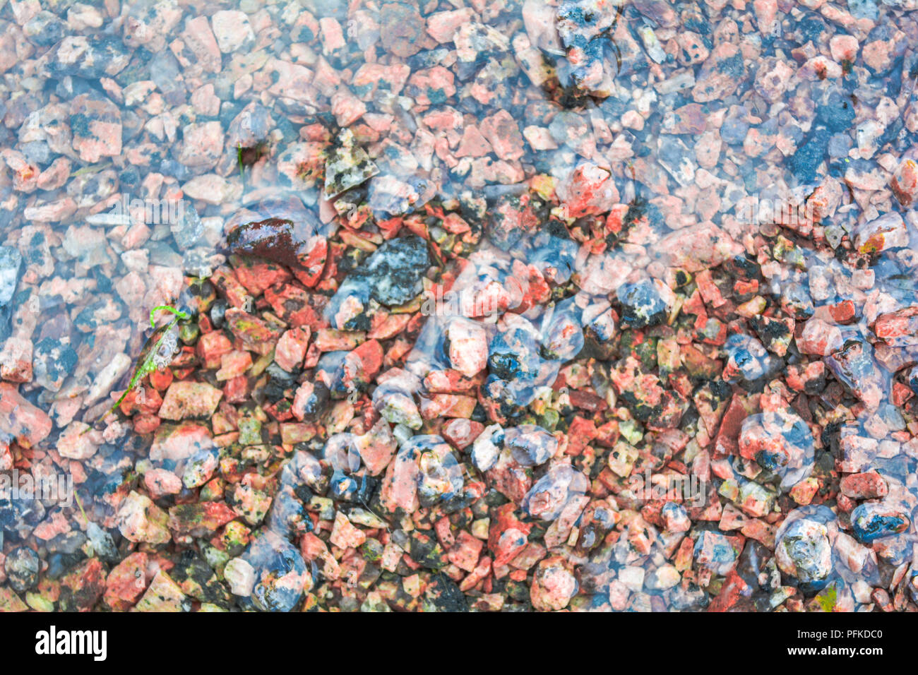 Brown texture of wet red granite Gravel. Sand and stones in water on ...