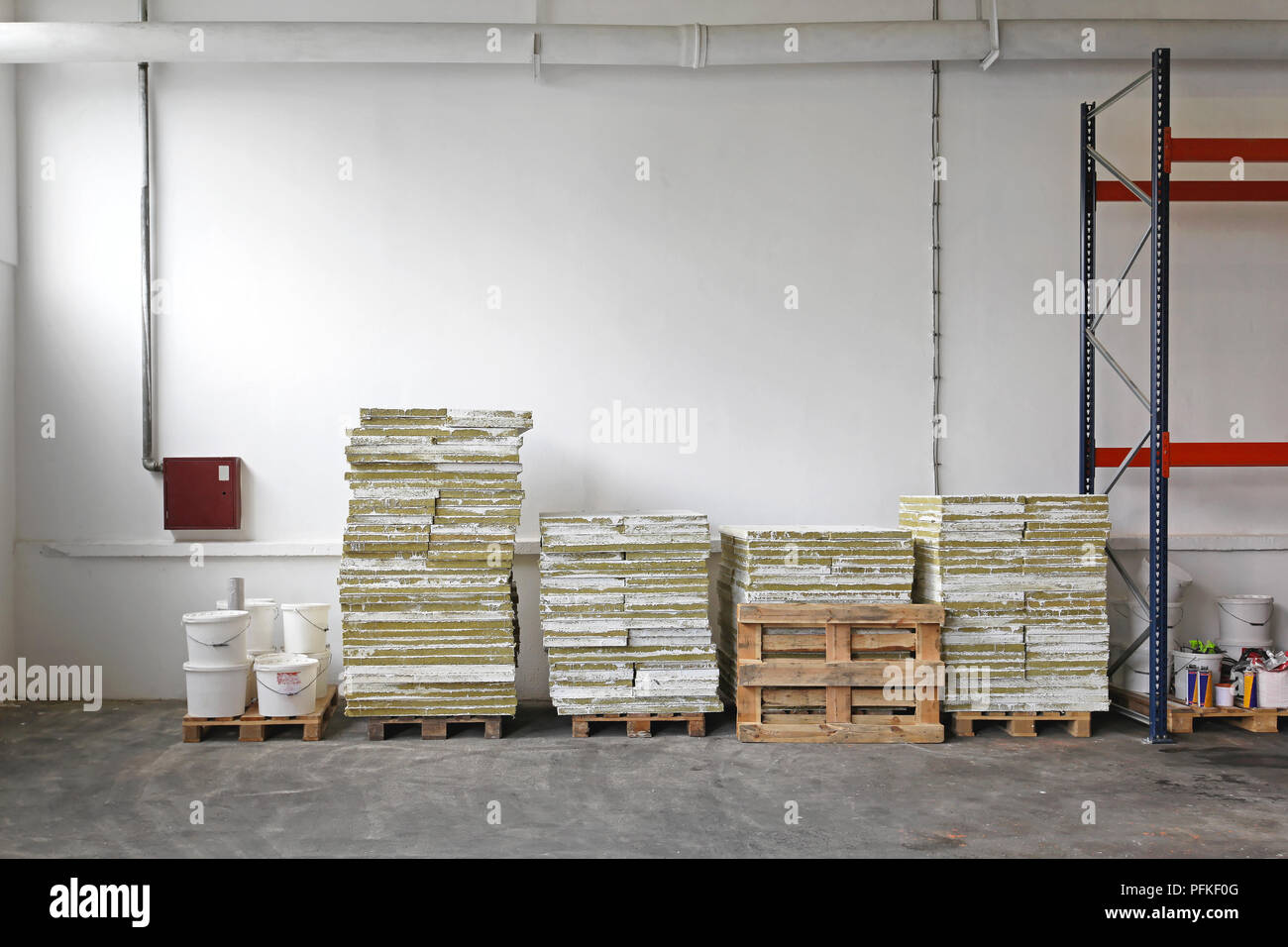 Pallets with construction material in storage room Stock Photo - Alamy