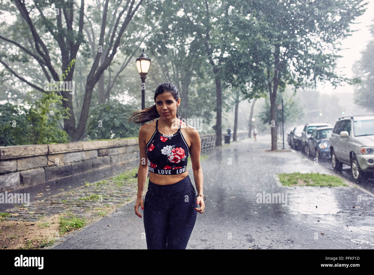 Female running rain hi-res stock photography and images - Alamy
