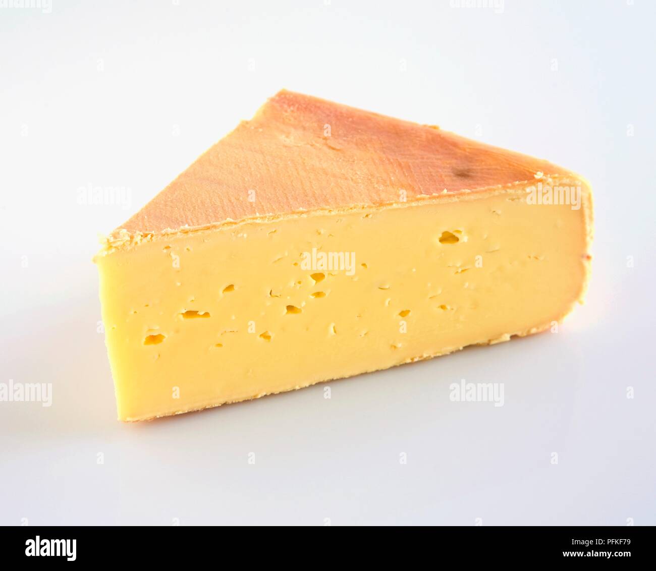 Slice of American Grayson cow's milk cheese Stock Photo - Alamy