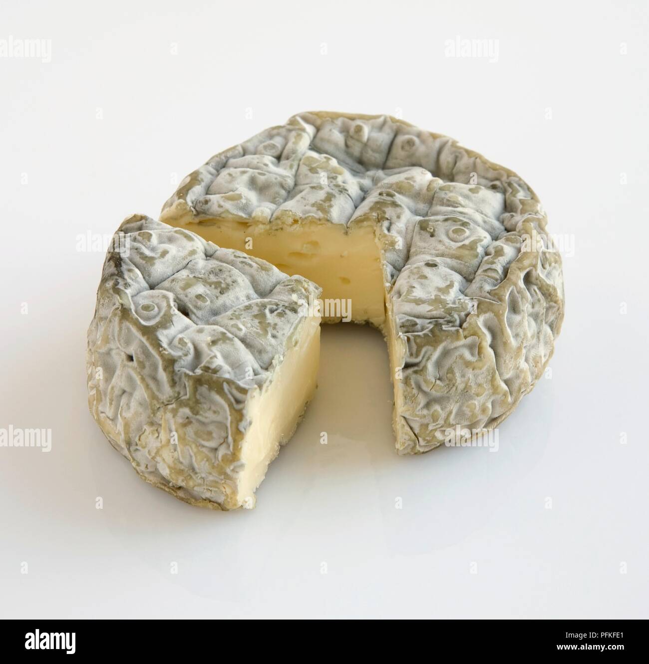 Round and slice of American Hubbardston Blue goat's cheese showing ...