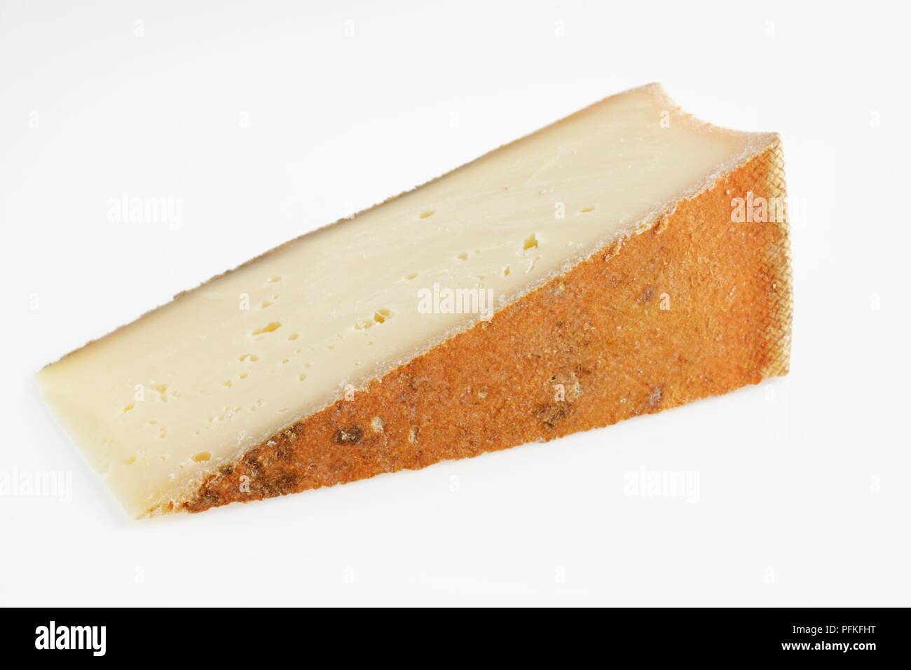 Slice of French Abondance AOC cow's milk cheese Stock Photo - Alamy