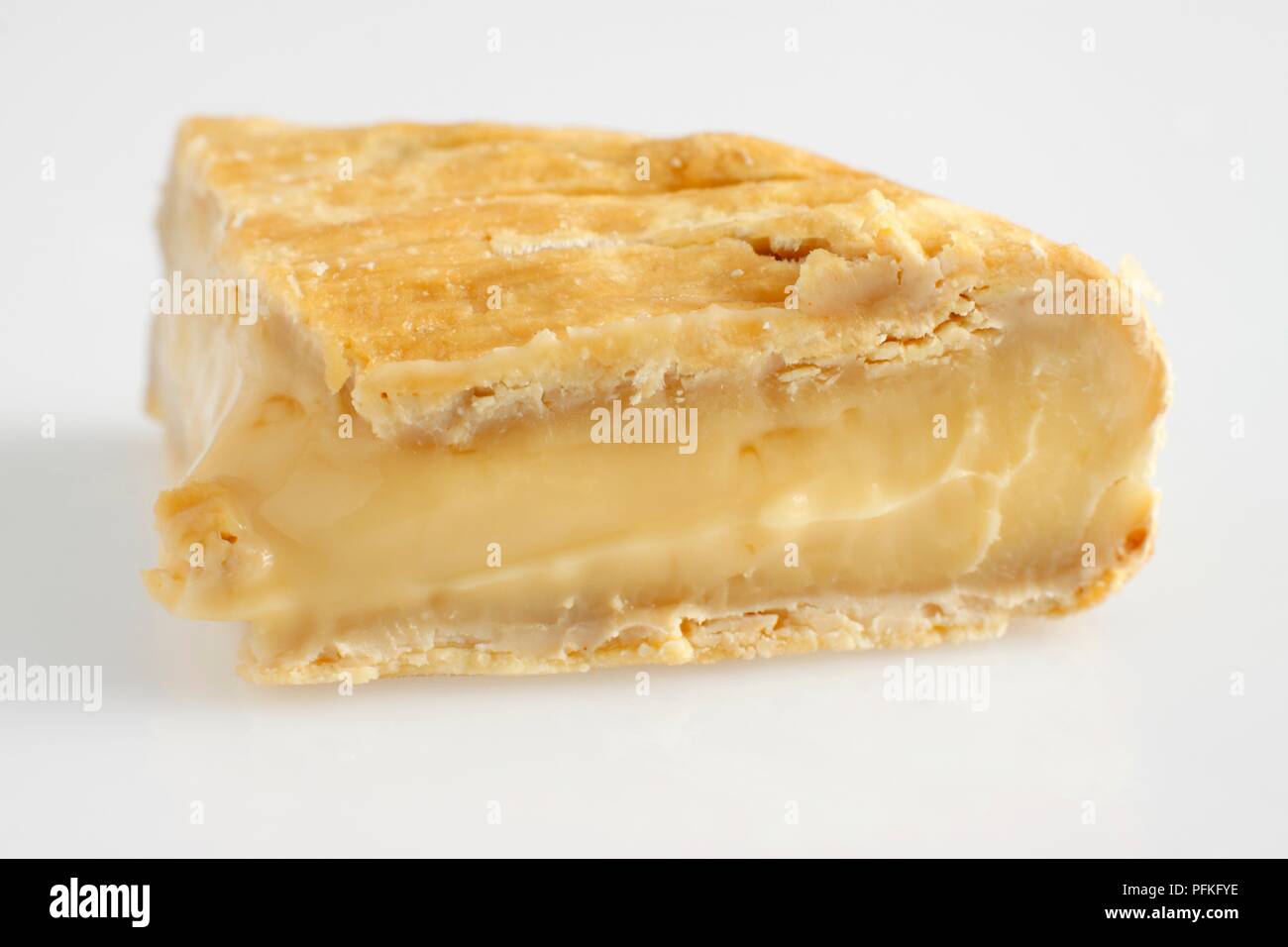 Slice of ripe French Banon AOC goat's cheese Stock Photo - Alamy