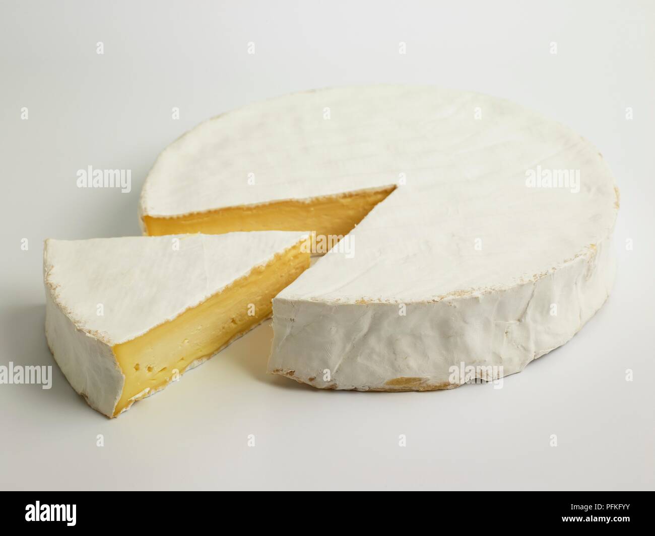 Round and slice of French Brie de Nangis cow's milk cheese Stock Photo ...