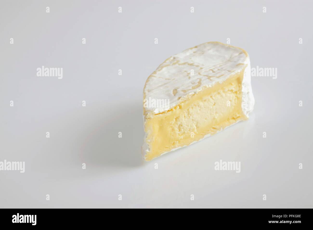 Slice of French Coeur de NeufcHotel AOC cow's milk cheese Stock Photo ...