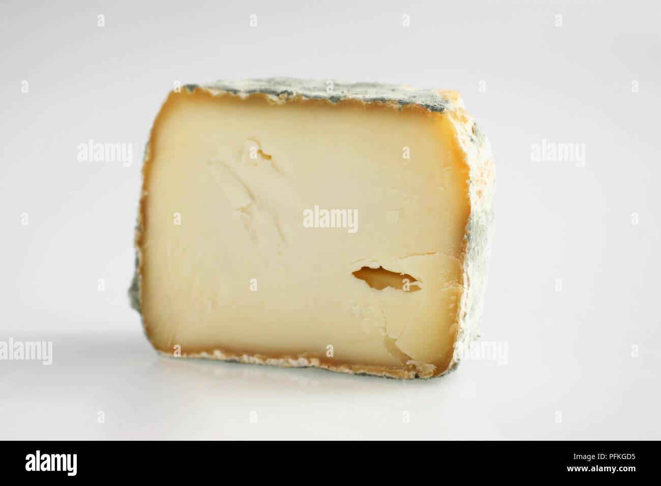 Slice of French Crottin de Chavignol AOC goat's cheese Stock Photo - Alamy