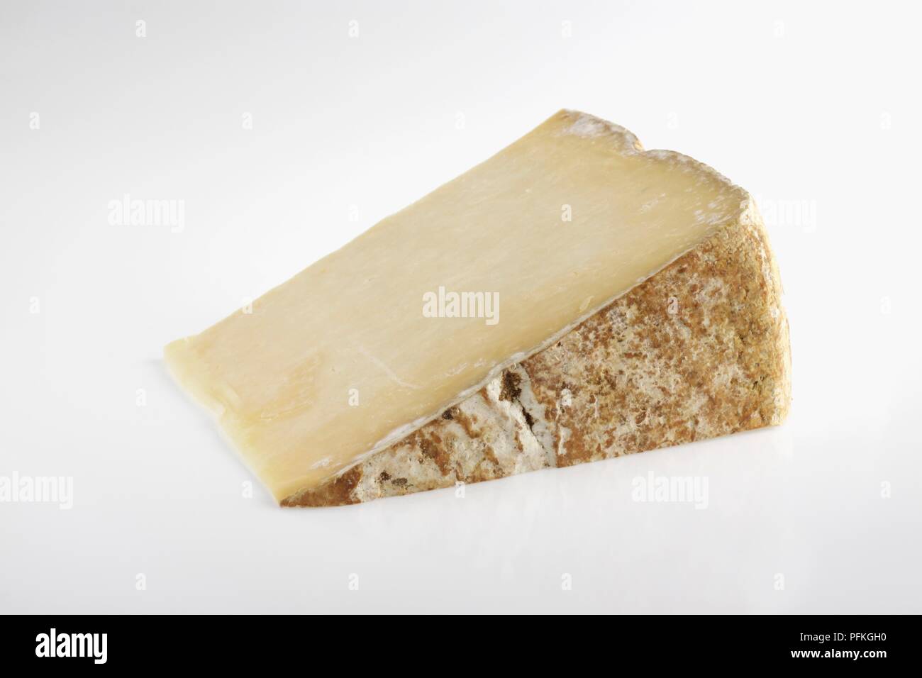Slice of Laguiole AOC cow's milk cheese Stock Photo - Alamy