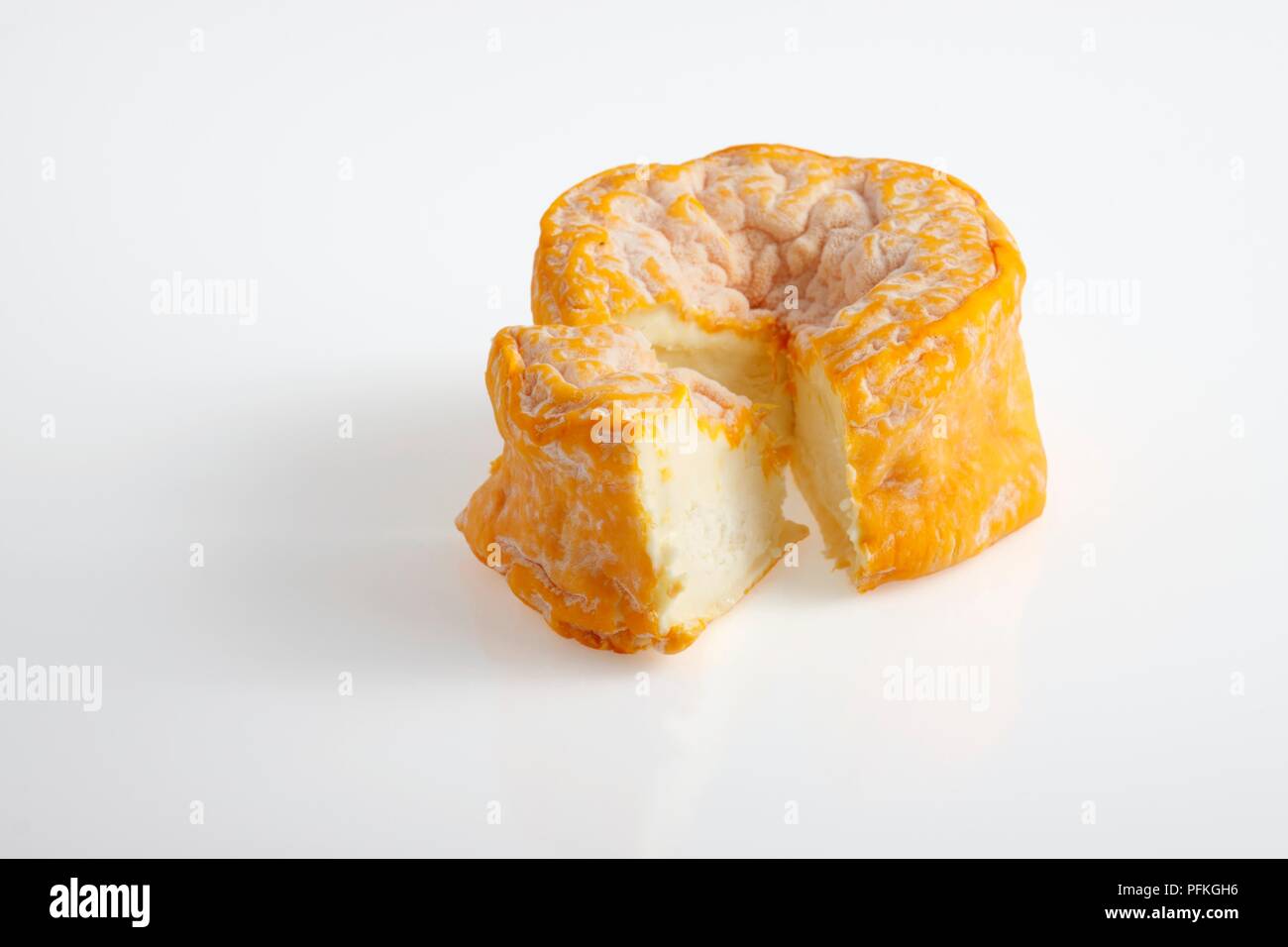 Round and slice of French Langres AOC cow's milk cheese showing sunken ...